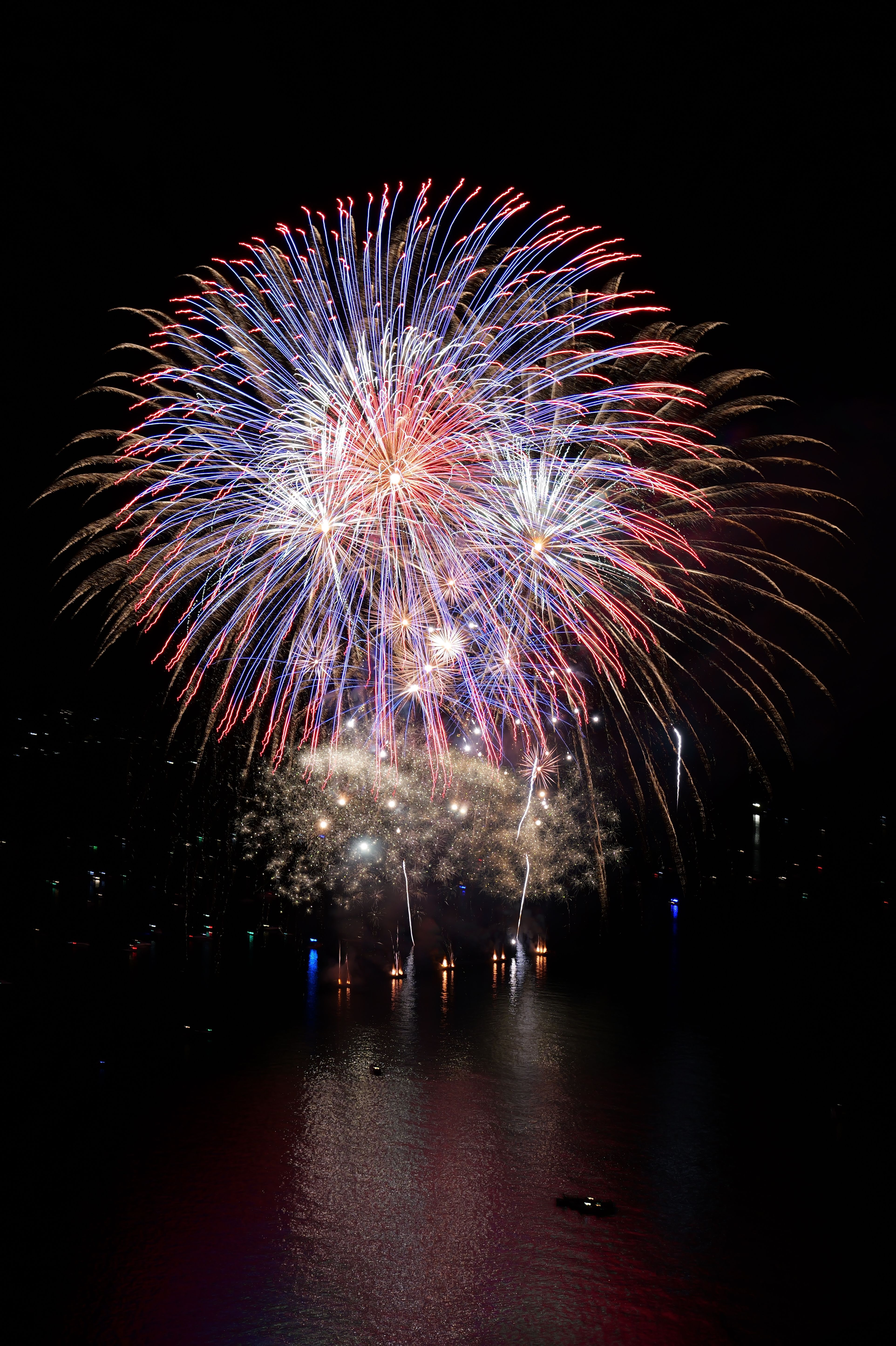 Spectacular Fireworks Over Water at Night · Free Stock Photo