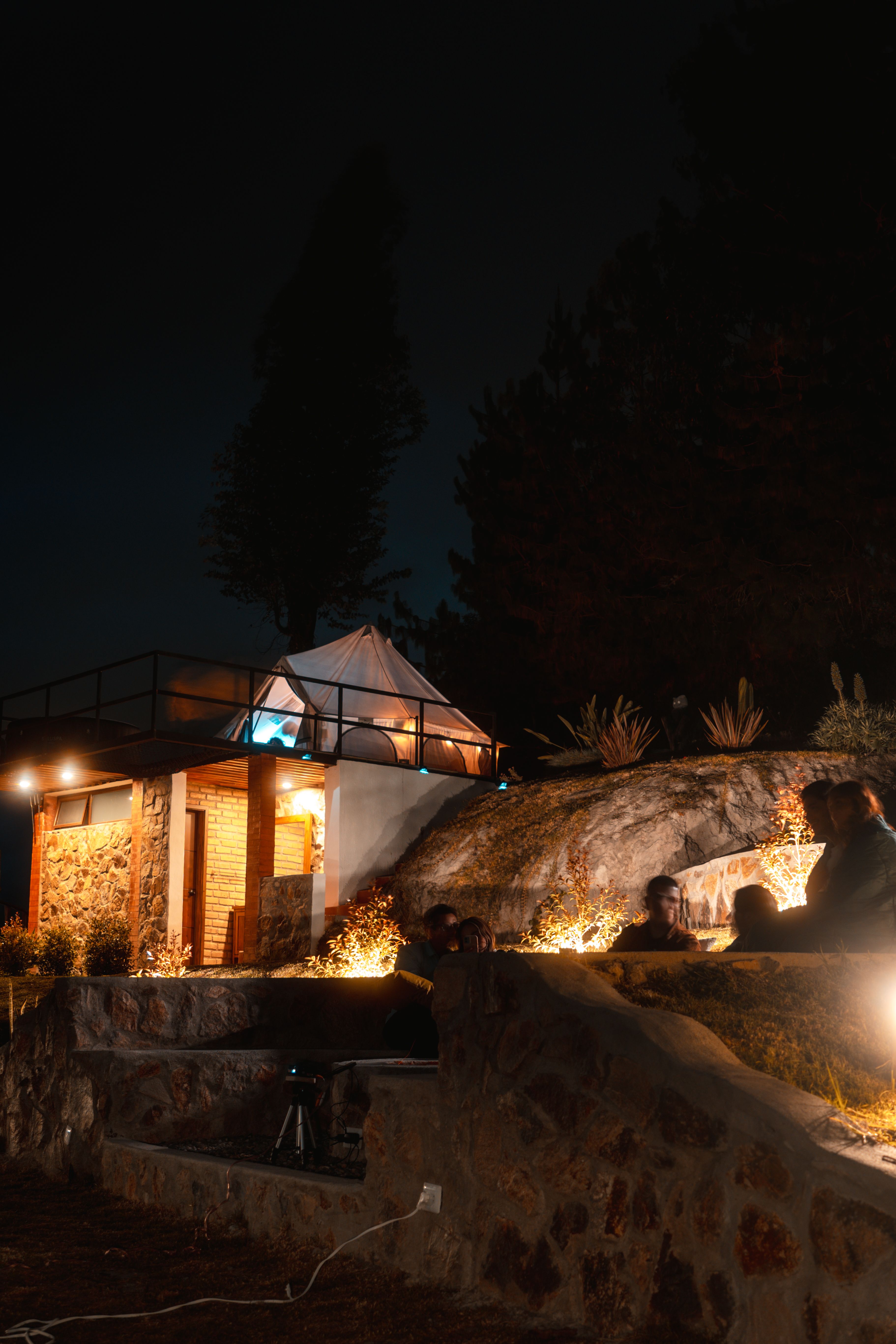 Cozy Outdoor Gathering at Night by Lit Cabin · Free Stock Photo