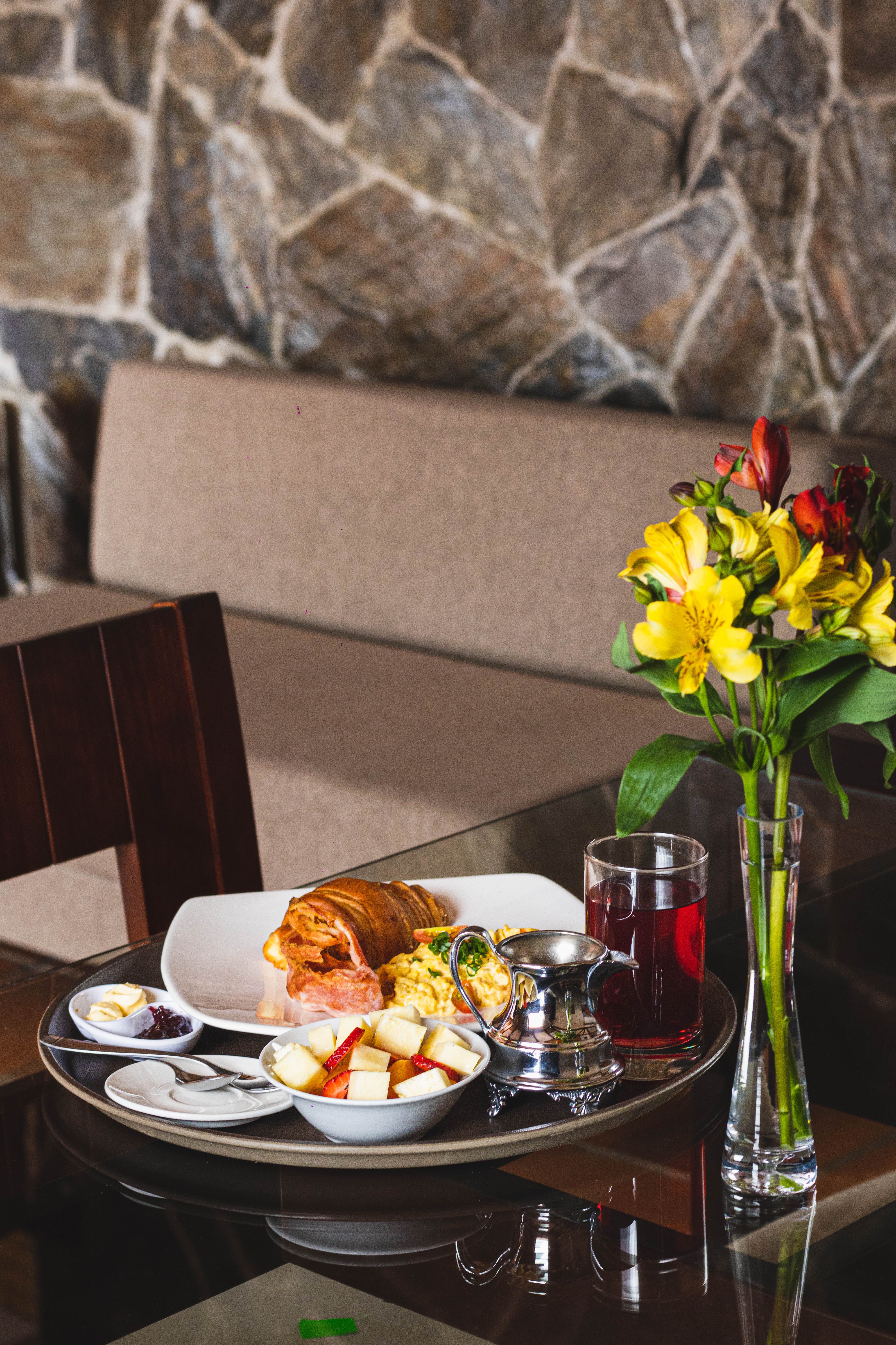 Elegant Breakfast Spread with Flowers on Table · Free Stock Photo