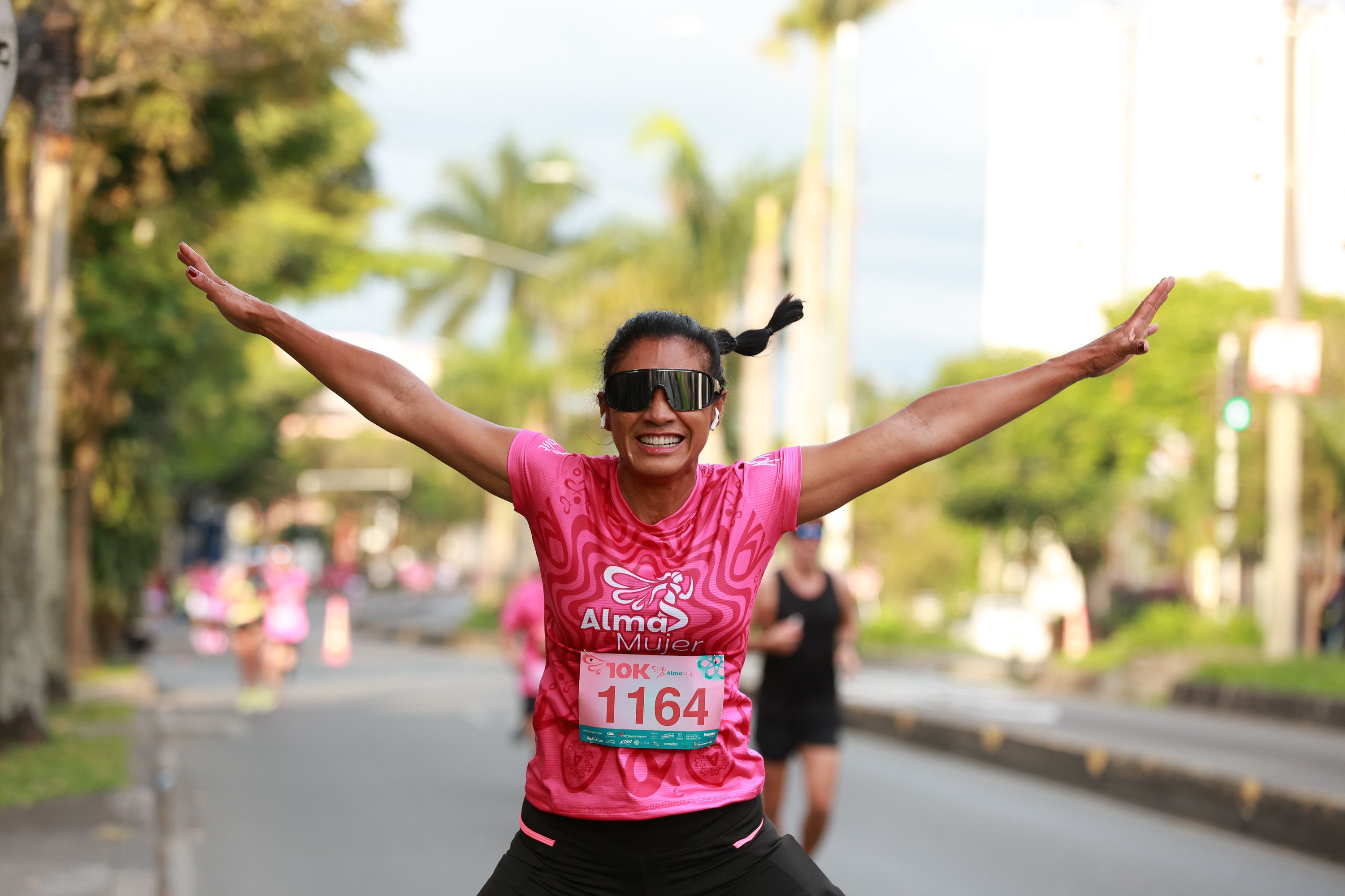 Joyful Female Runner Celebrating Finish Line in Race · Free Stock Photo