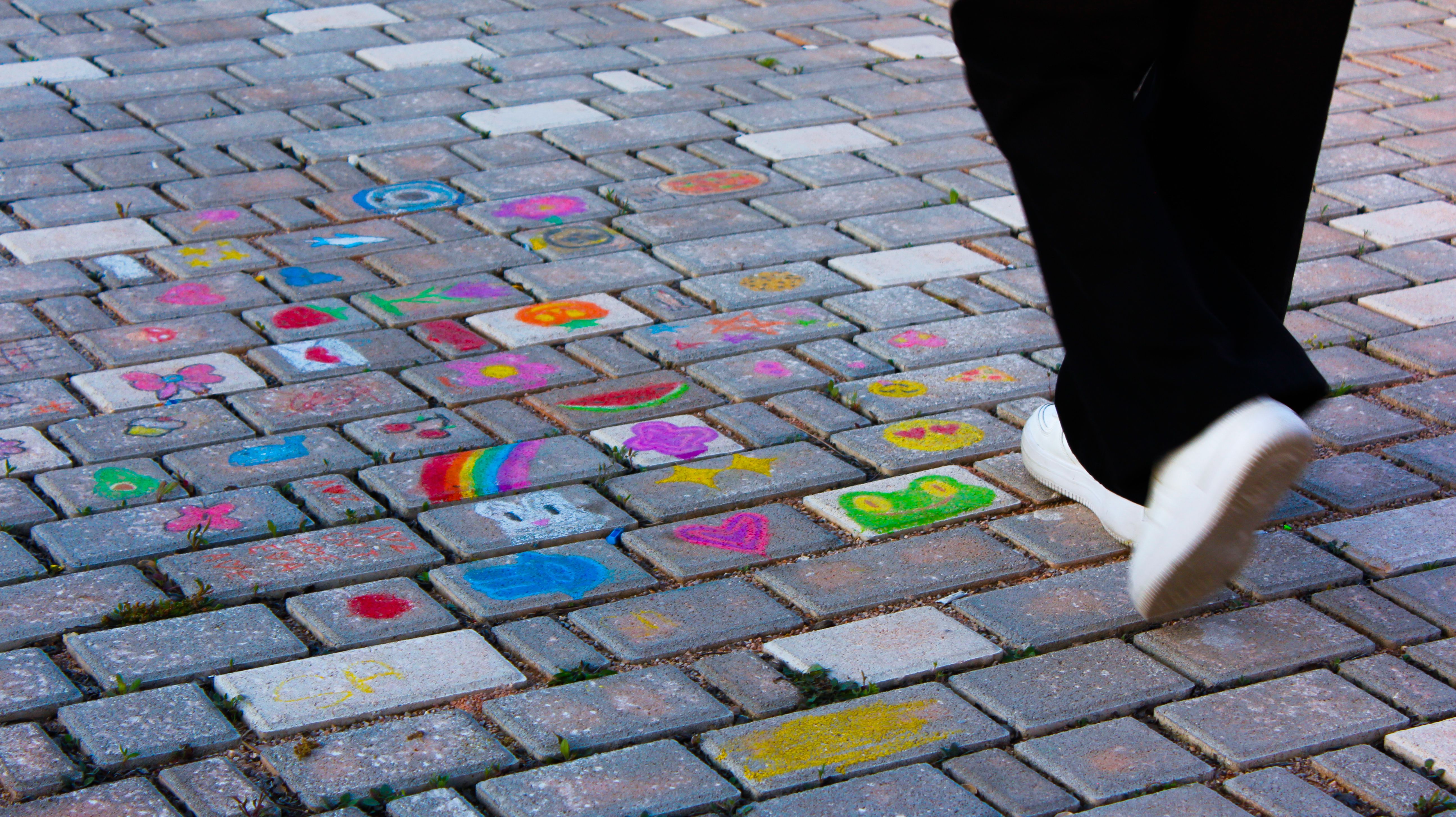 Colorful Chalk Art on Brick Pathway with Walking Feet · Free Stock Photo