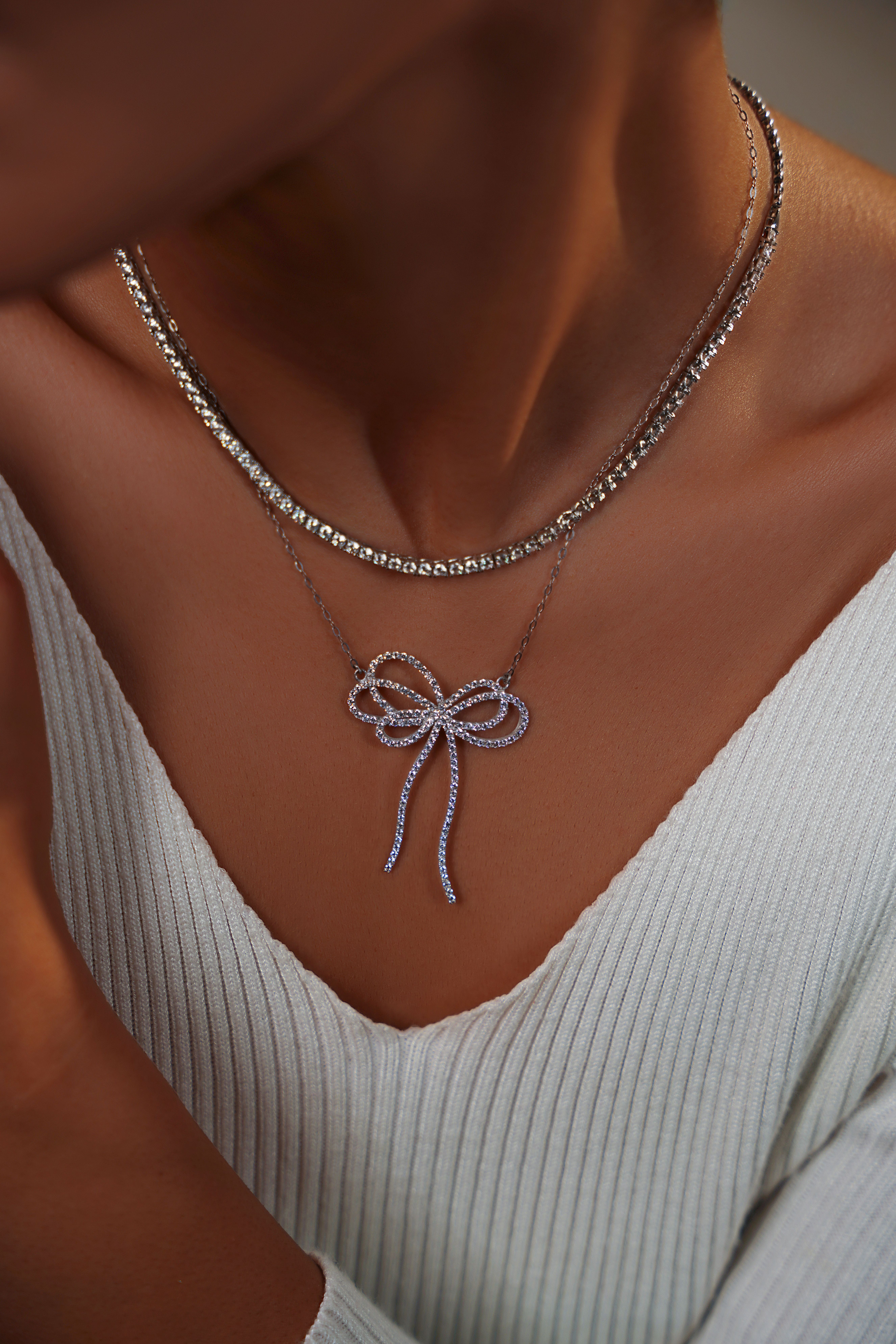 Elegant Bow Pendant Necklace on Woman's Neck · Free Stock Photo