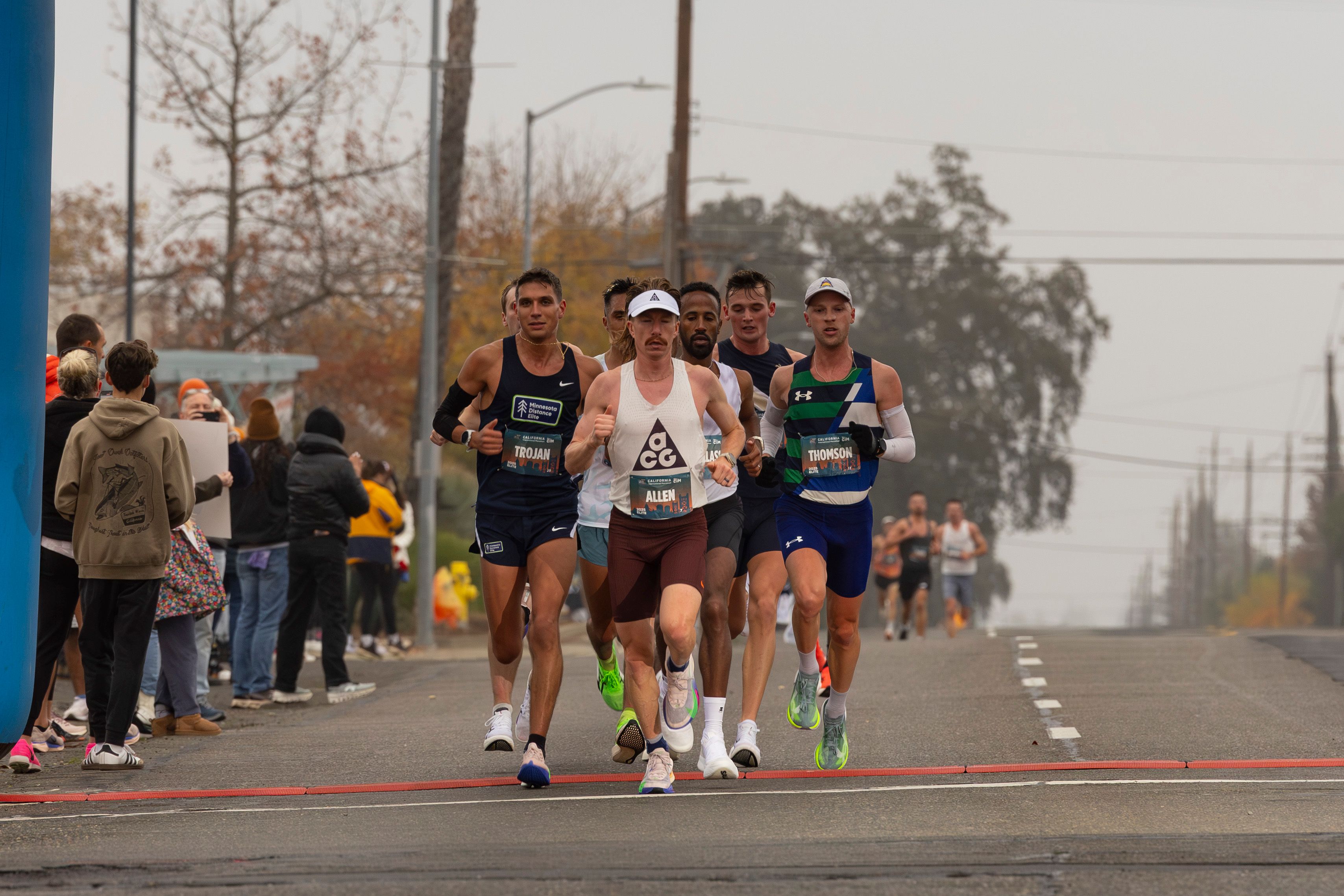 Competitive Marathon Runners Racing Outdoors · Free Stock Photo