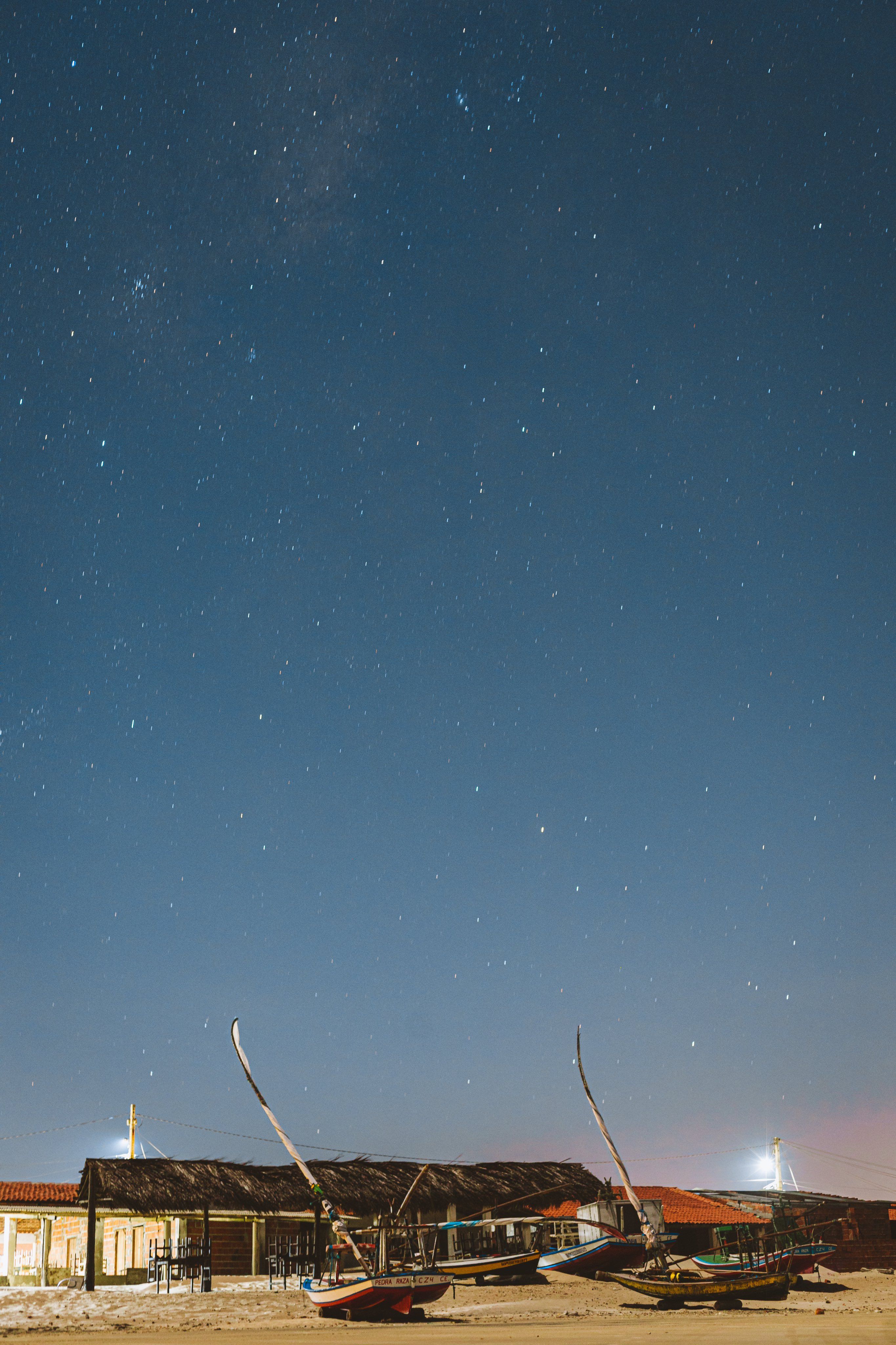 Starry Night Sky Over Rustic Fishing Village · Free Stock Photo