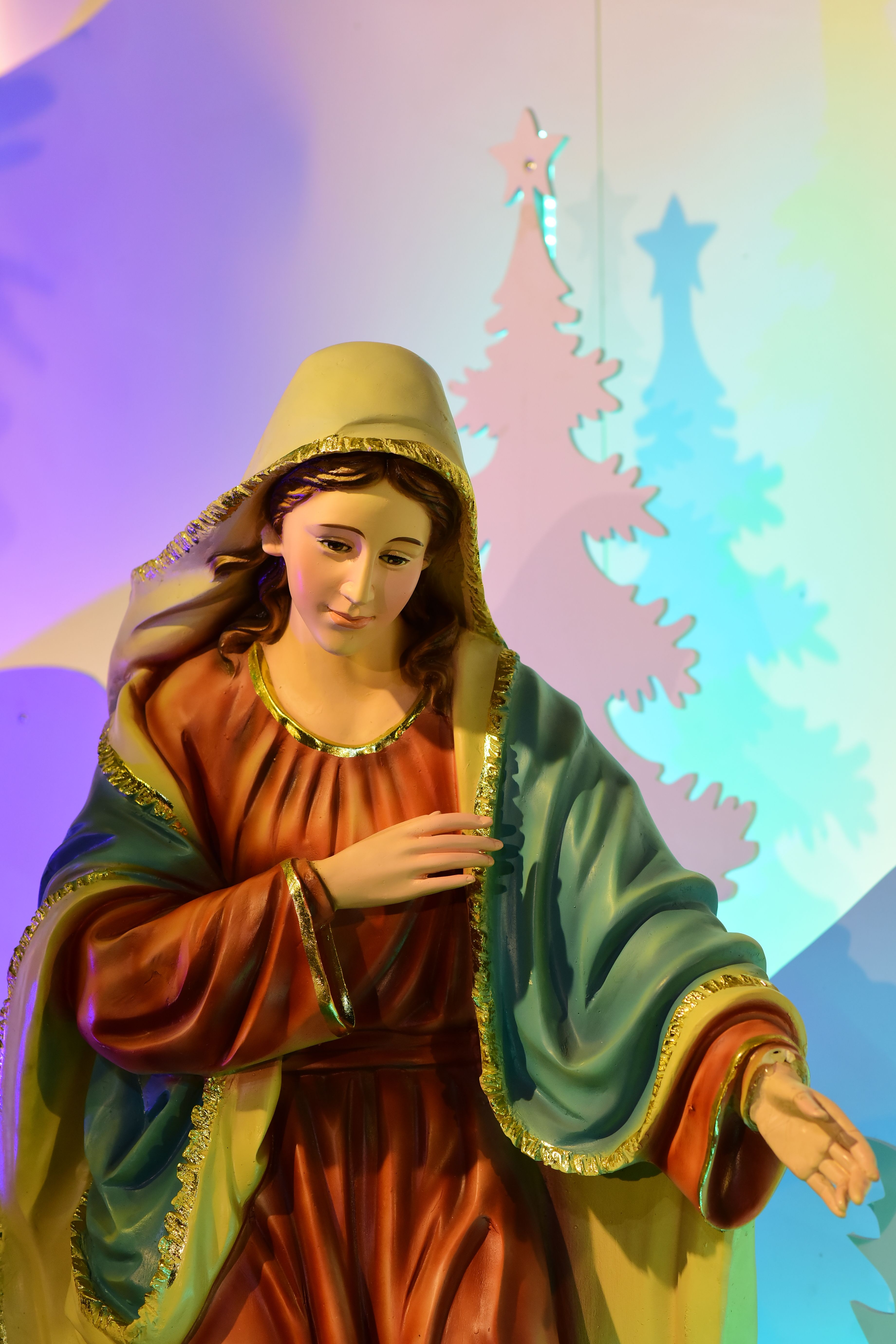 Colorful Statue of Religious Figure with Holiday Decor · Free Stock Photo