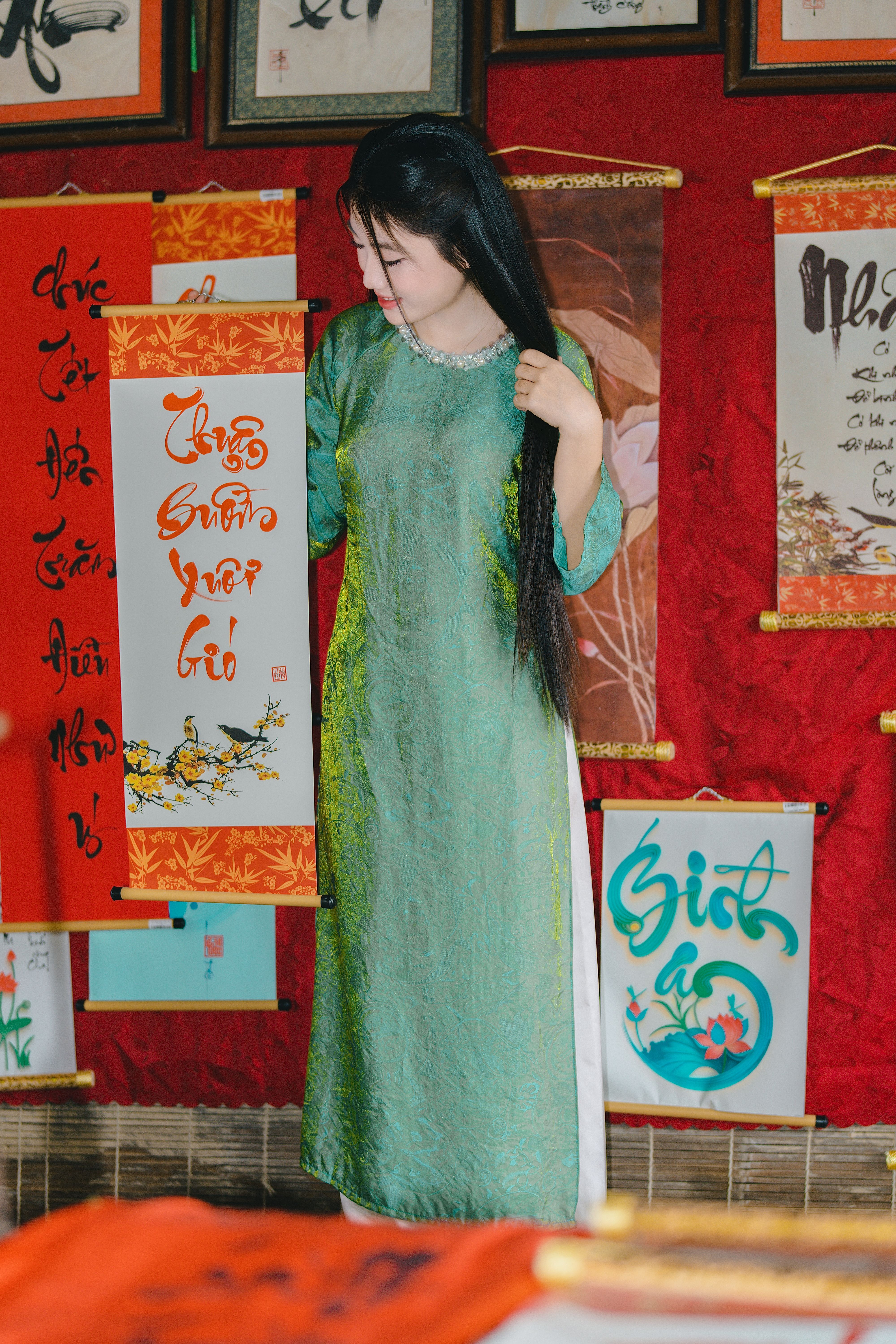 Woman in Traditional Dress with Calligraphy Artworks · Free Stock Photo