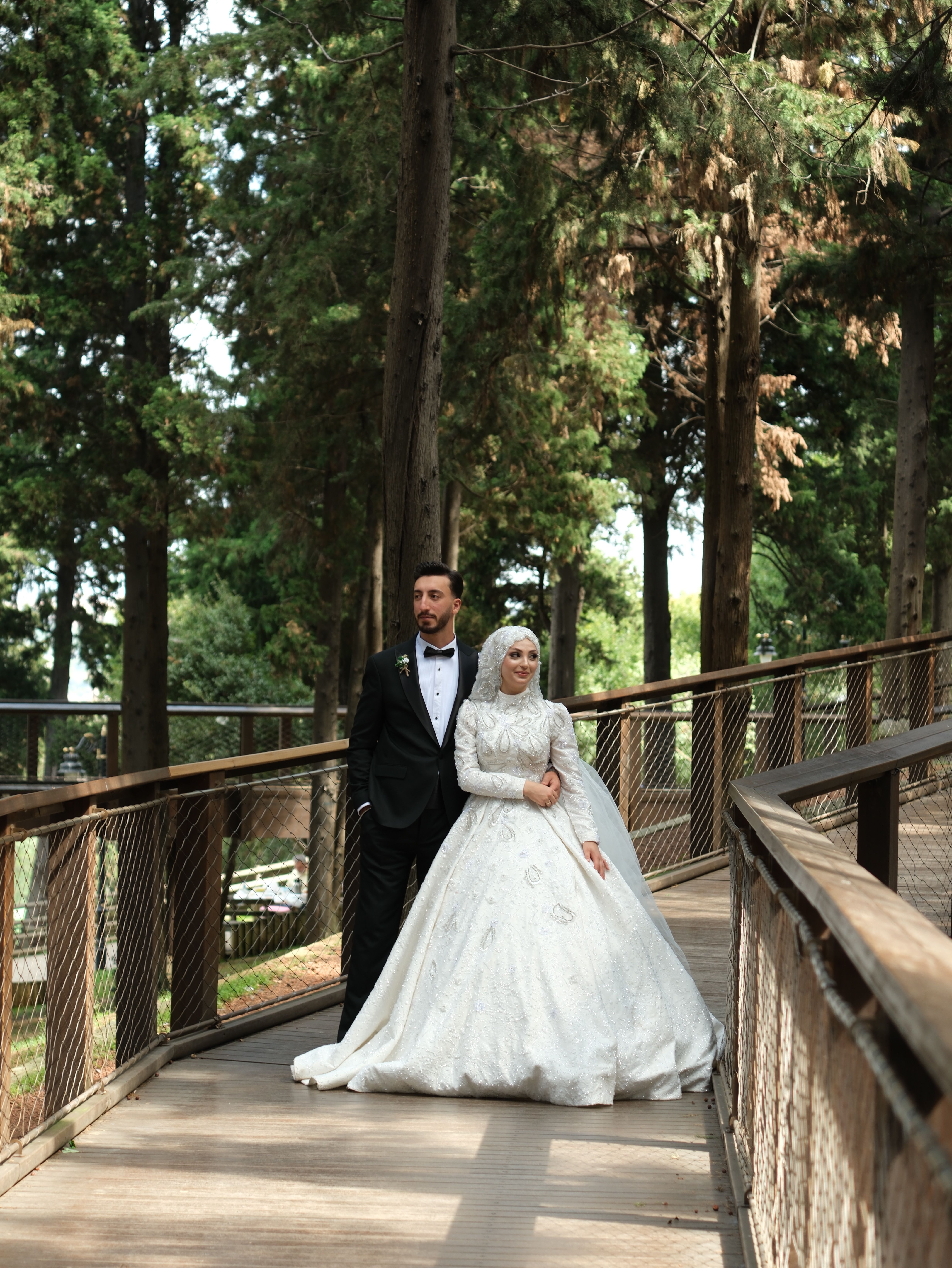 Elegant Outdoor Wedding Portrait on Forest Walkway · Free Stock Photo