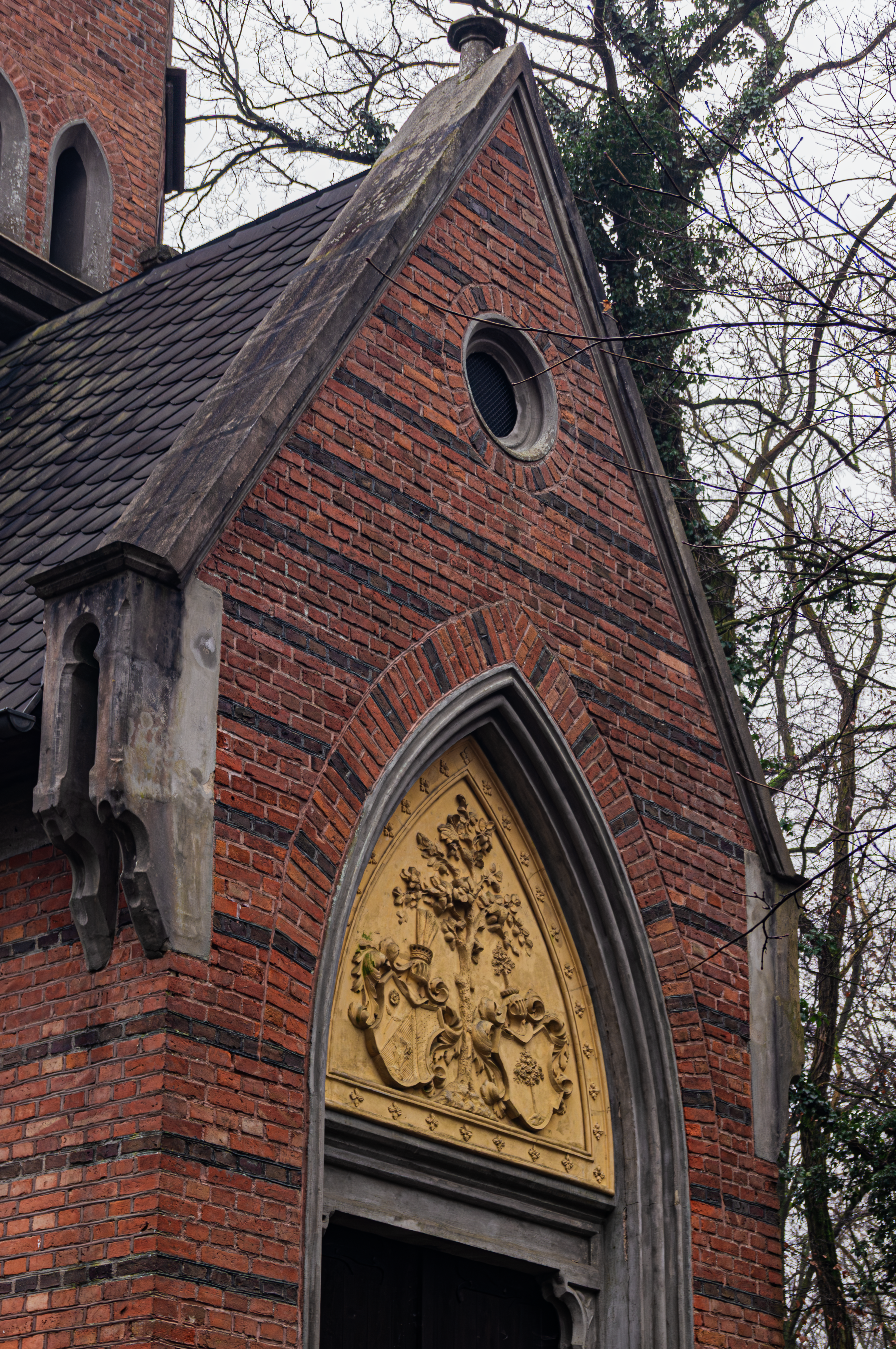 Gothic Brick Chapel Facade with Decorated Archway · Free Stock Photo