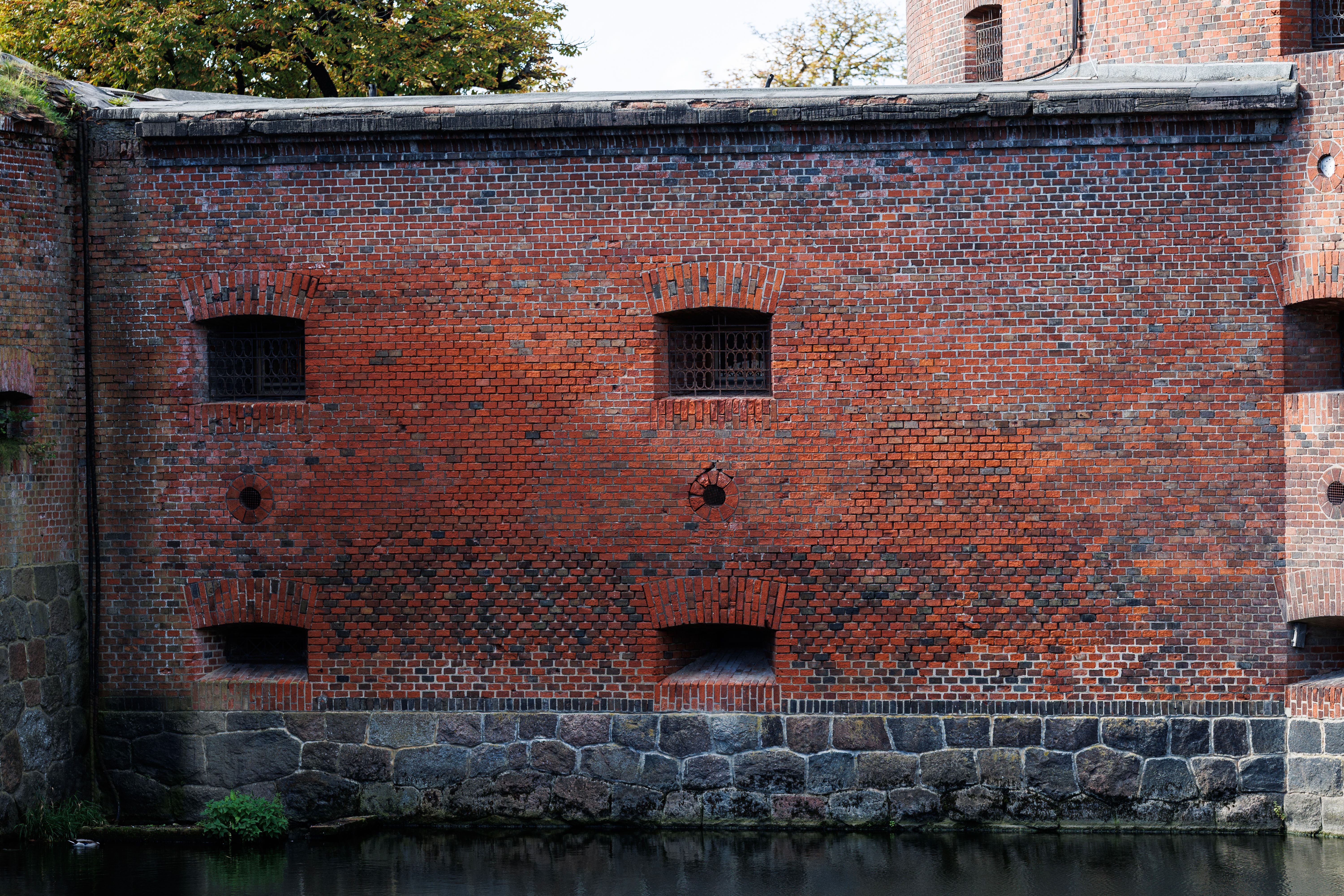 Historic Brick Fort Wall by Water · Free Stock Photo