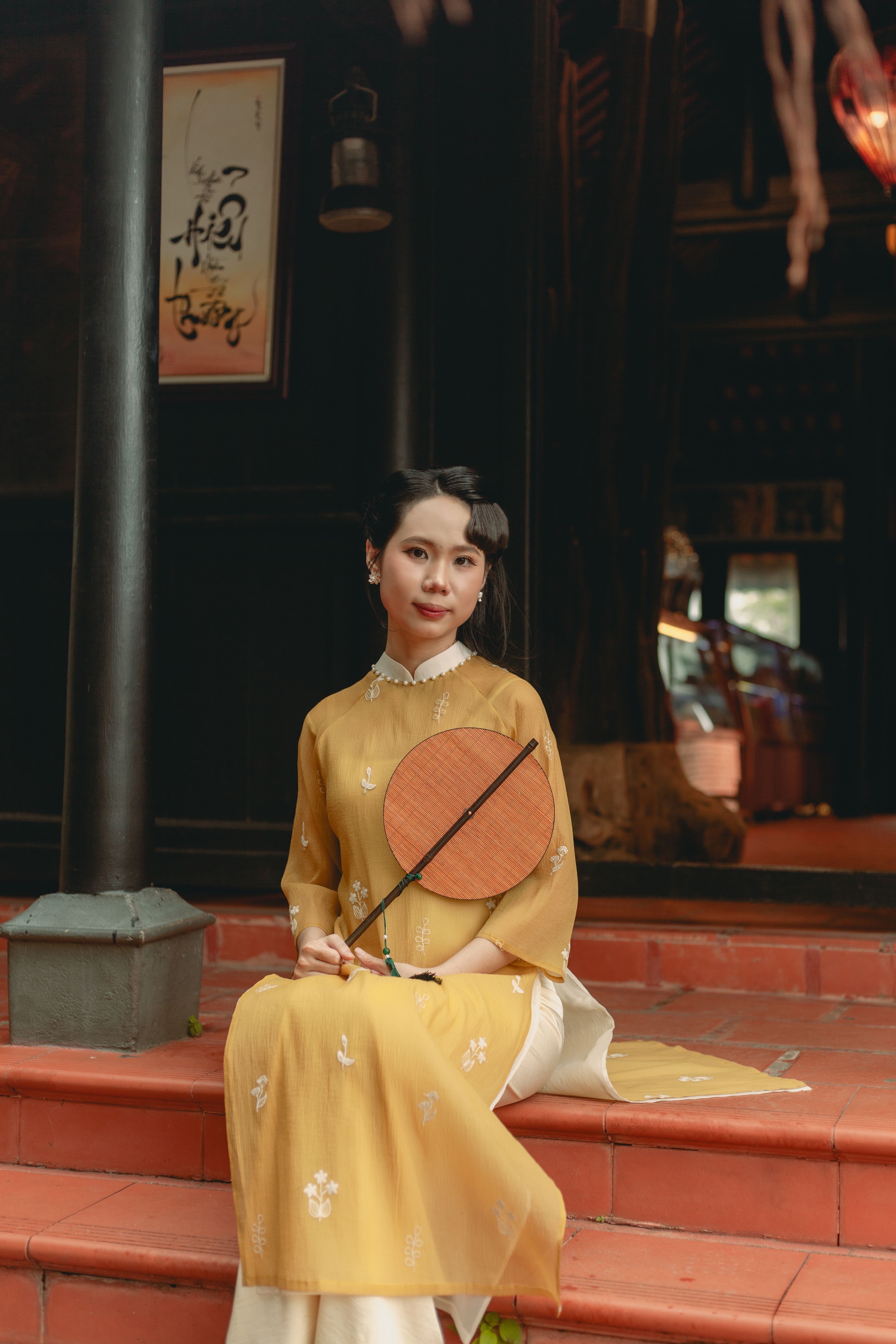 Elegant Woman in Traditional Yellow Dress Sitting on Steps · Free Stock ...