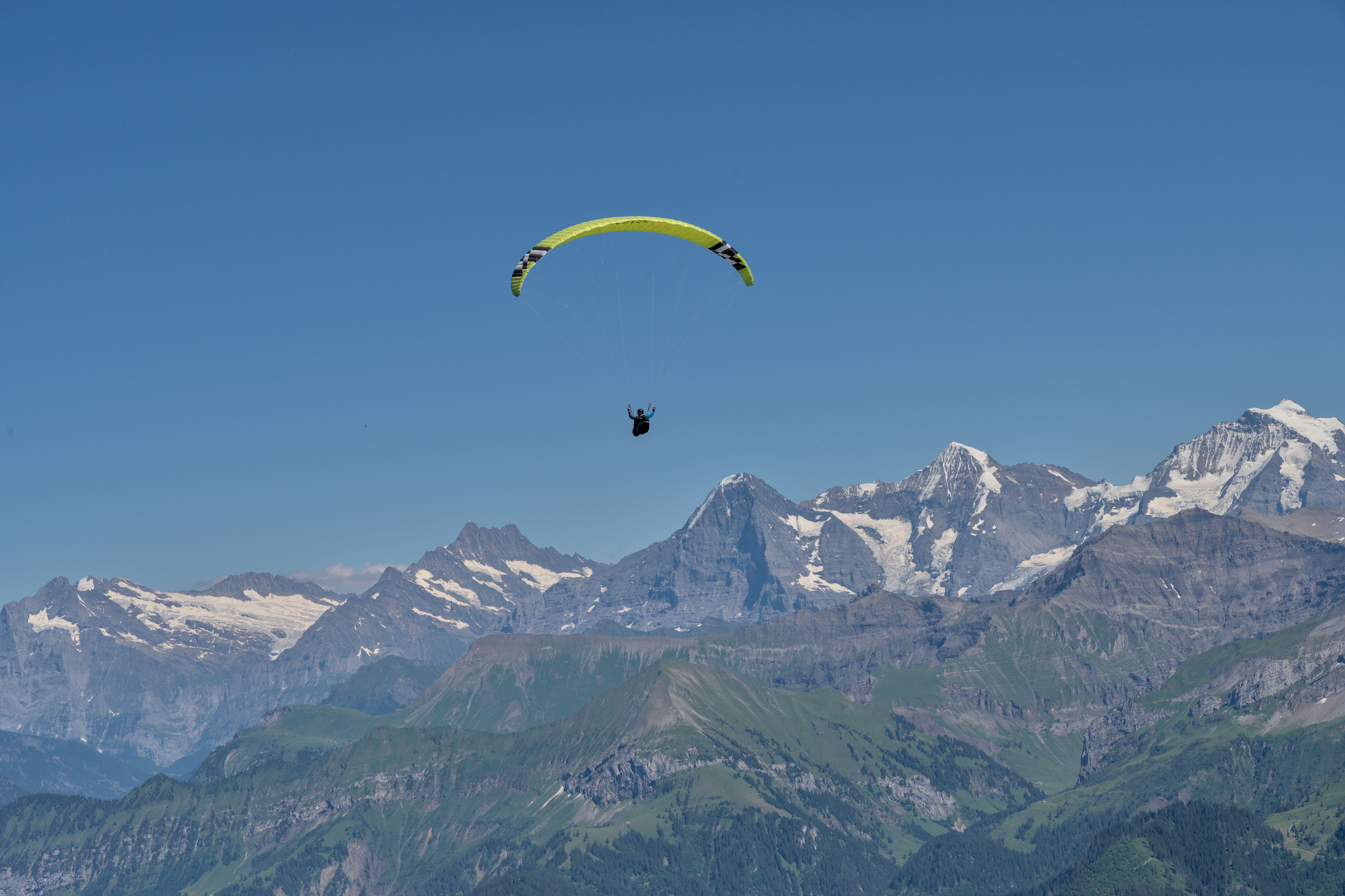 Paraglider Soaring Over Swiss Alps Panorama · Free Stock Photo