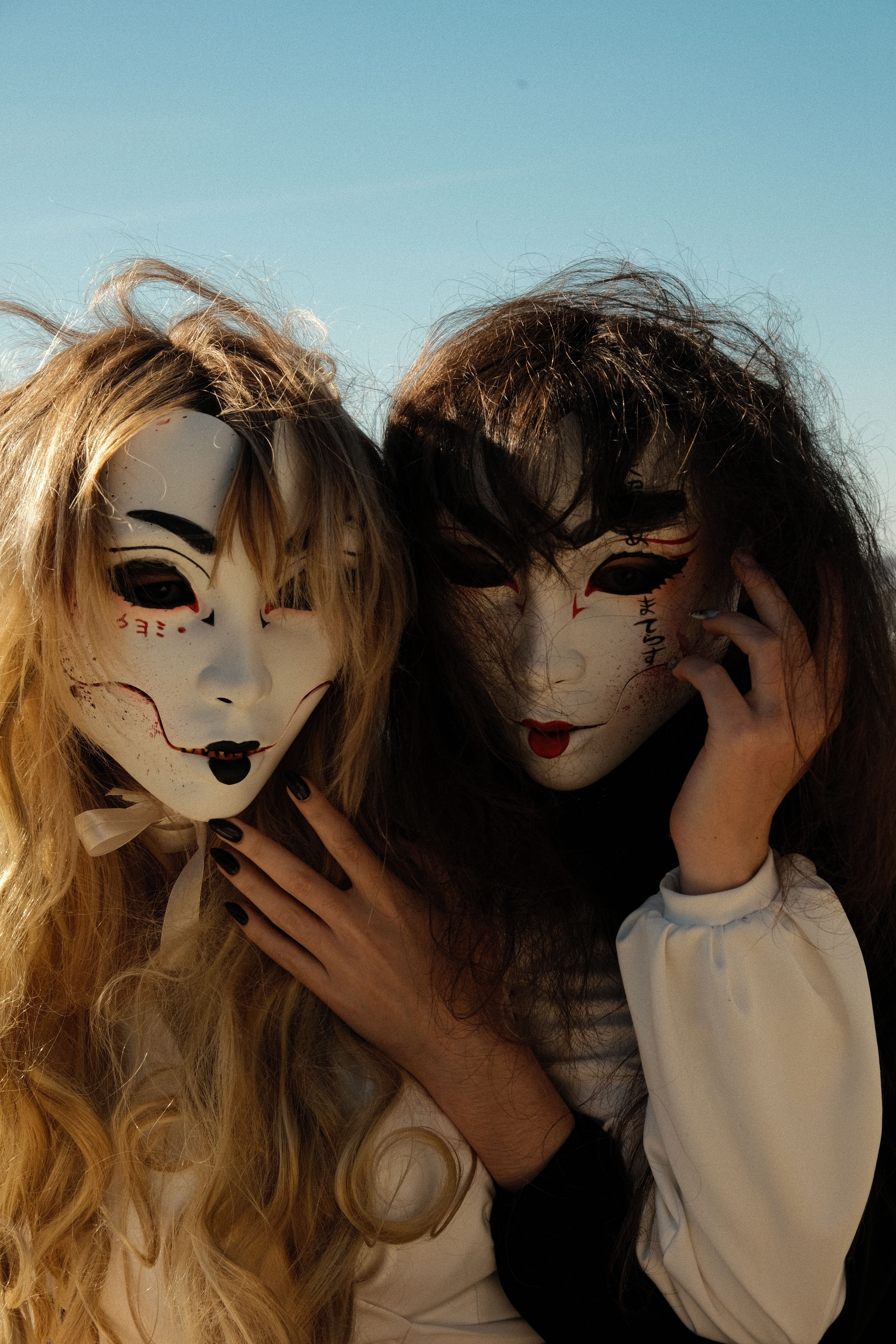 Masked Figures in Dramatic Outdoor Setting · Free Stock Photo