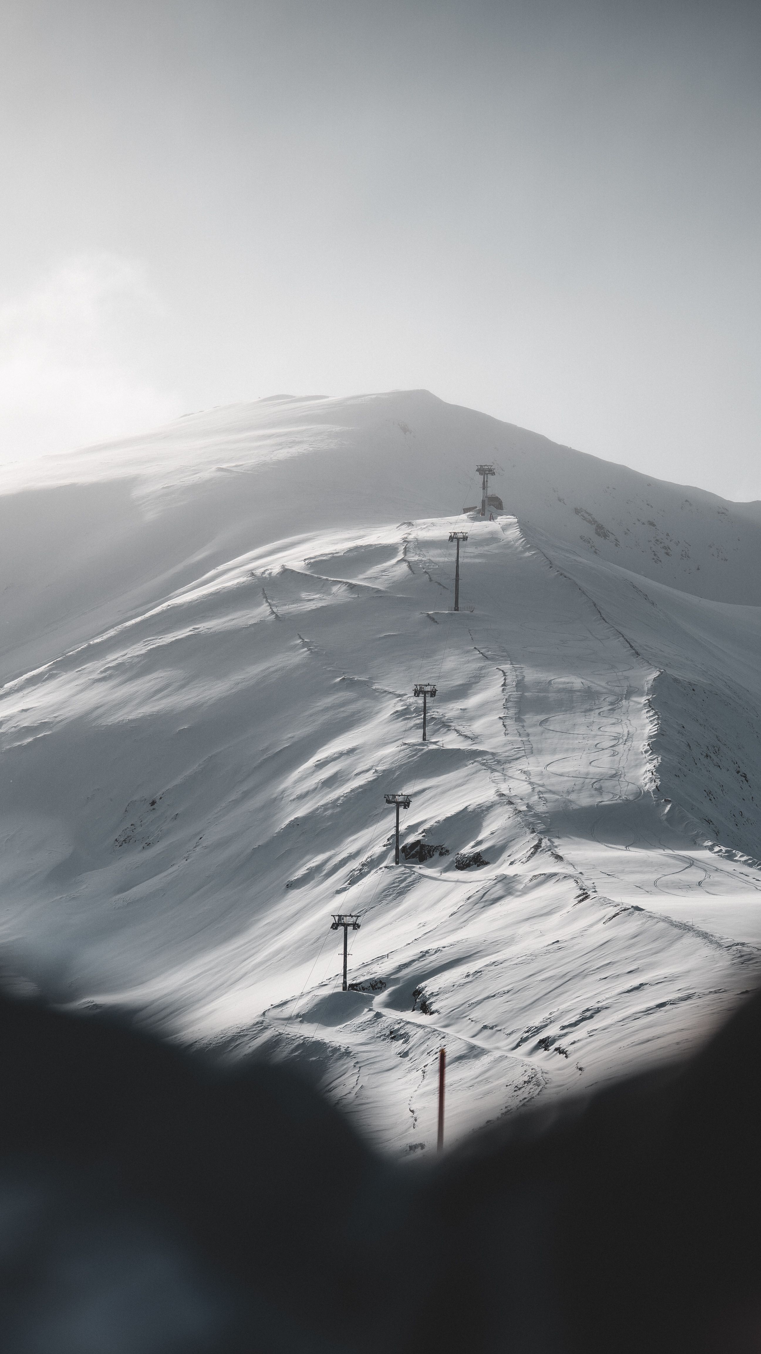 Snowy Mountain Summit with Ski Lift in Winter · Free Stock Photo