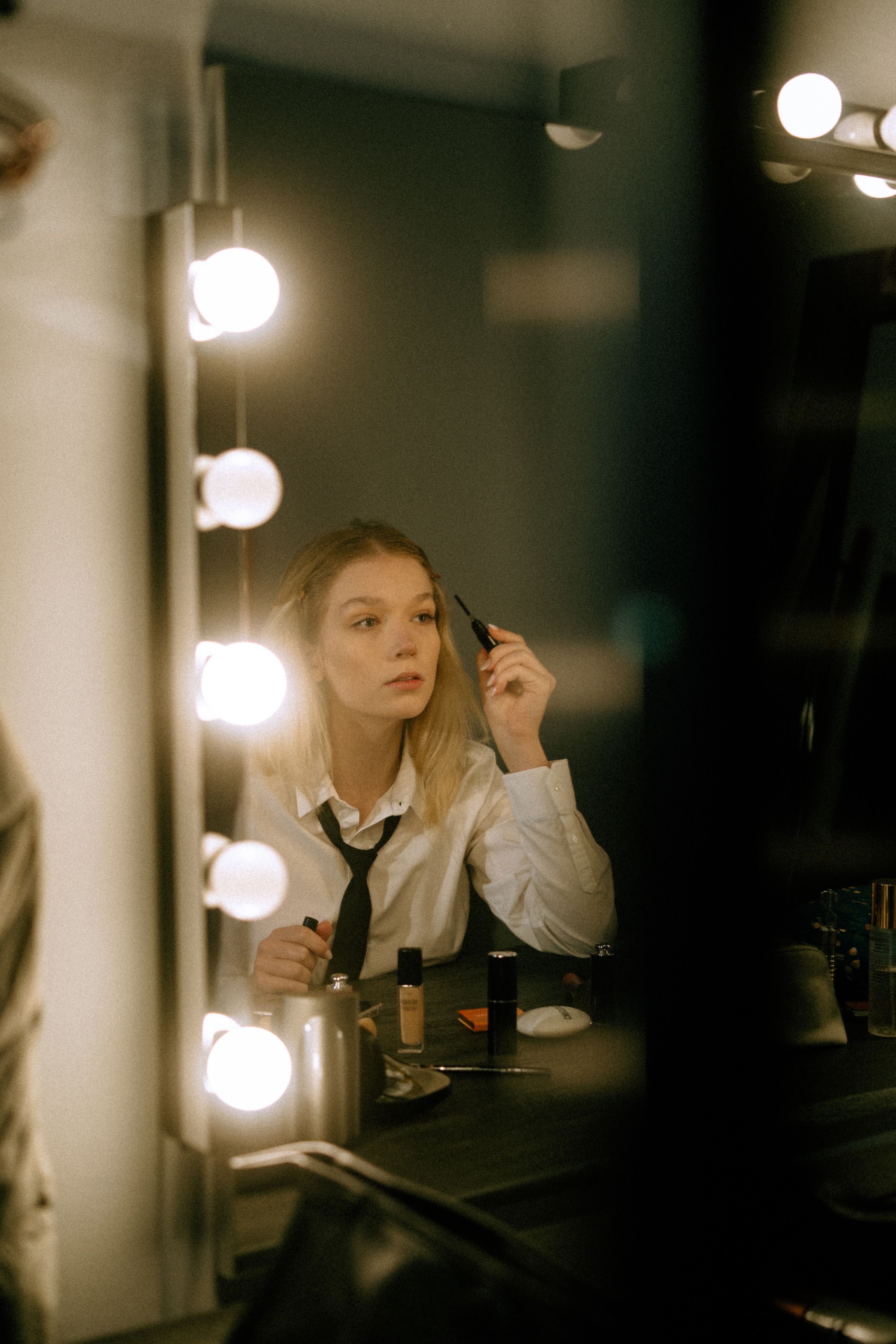 Woman Looking at a Vanity Mirror · Free Stock Photo