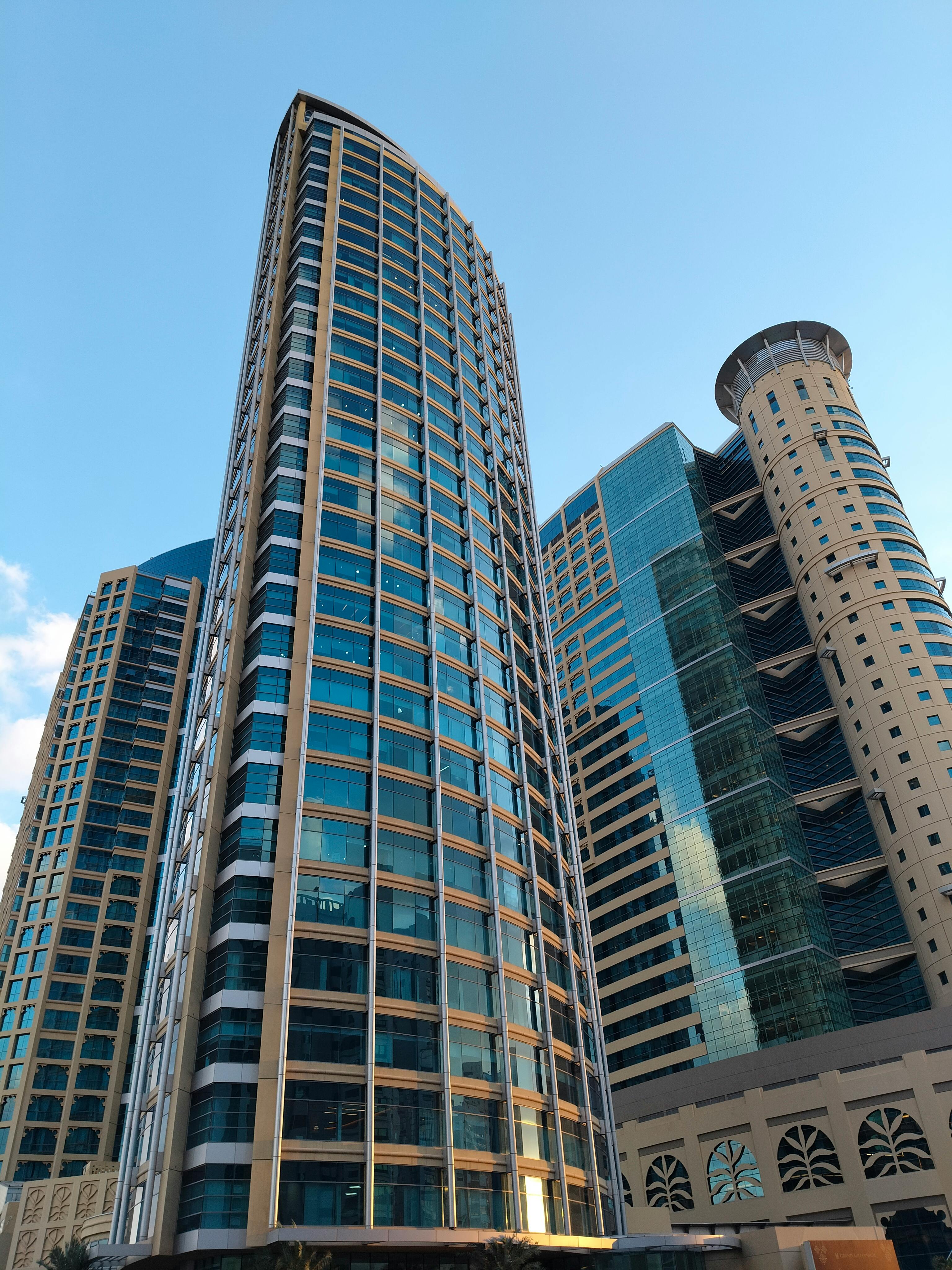 Modern High-Rise Towers Against Blue Sky · Free Stock Photo