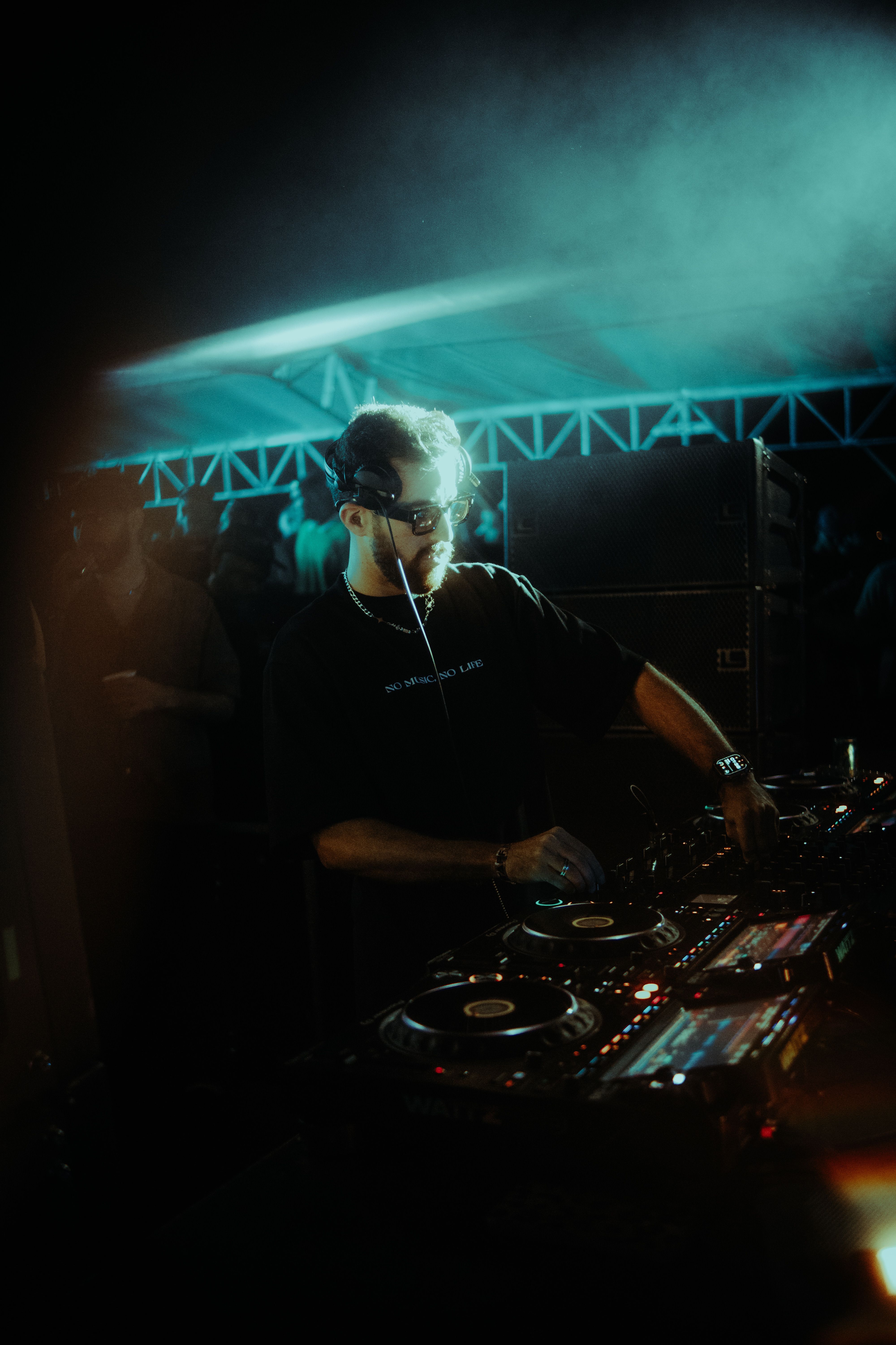 DJ Performing Live at Nightclub Event · Free Stock Photo