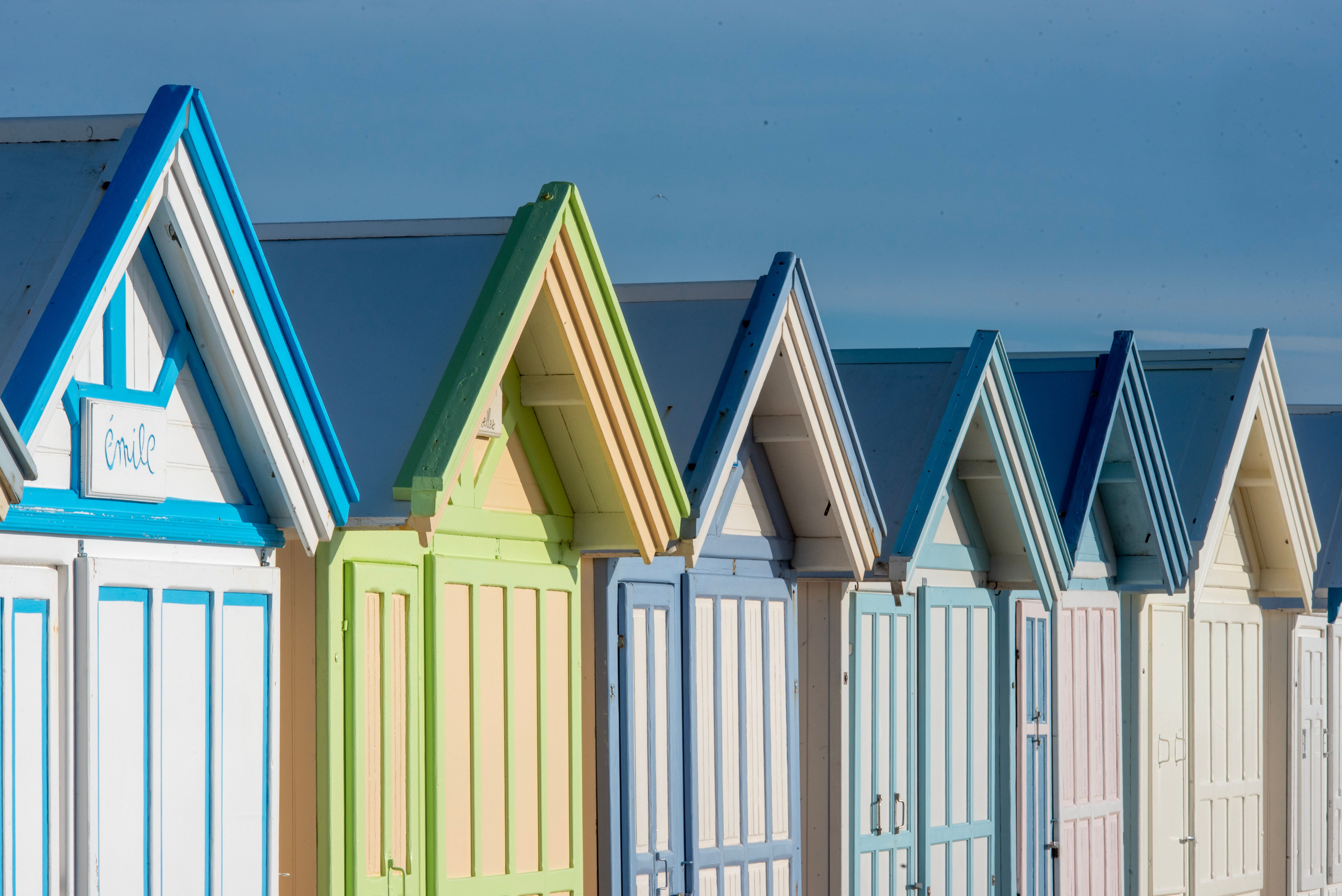 Colorful Beach Huts Under Blue Sky · Free Stock Photo