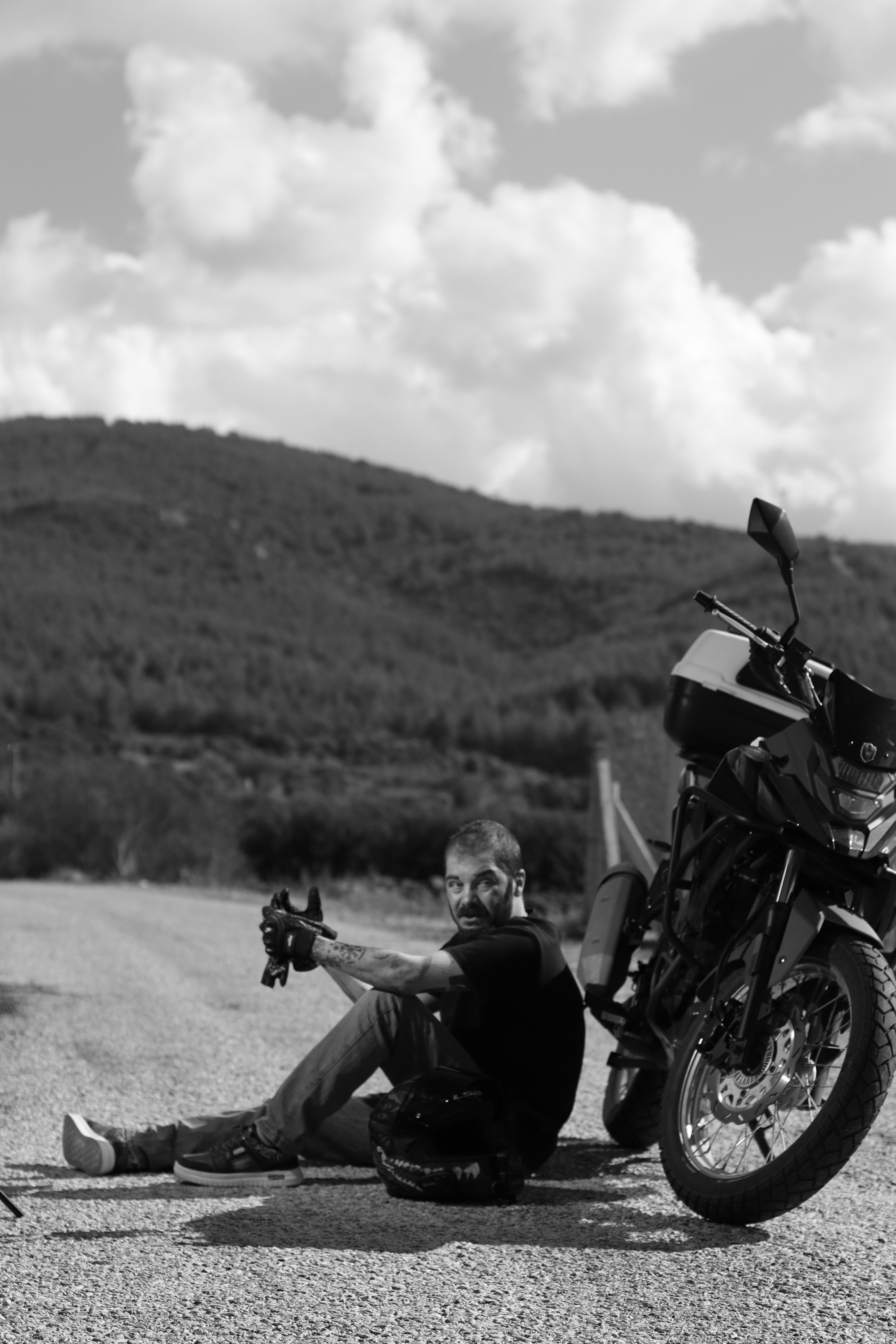 Biker Relaxing on Rural Road with Motorcycle · Free Stock Photo