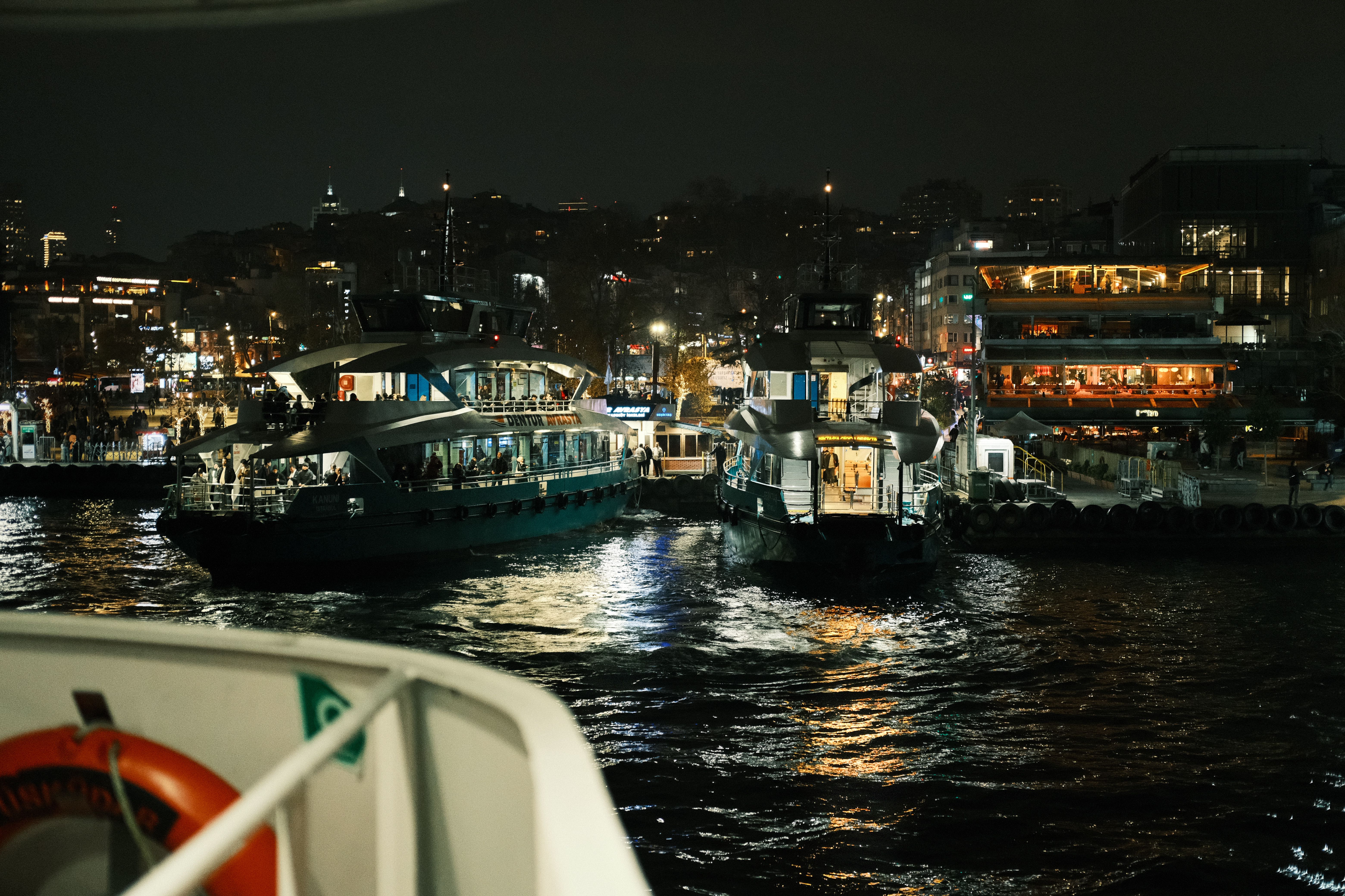 Nighttime Harbor Scene with Illuminated Boats · Free Stock Photo