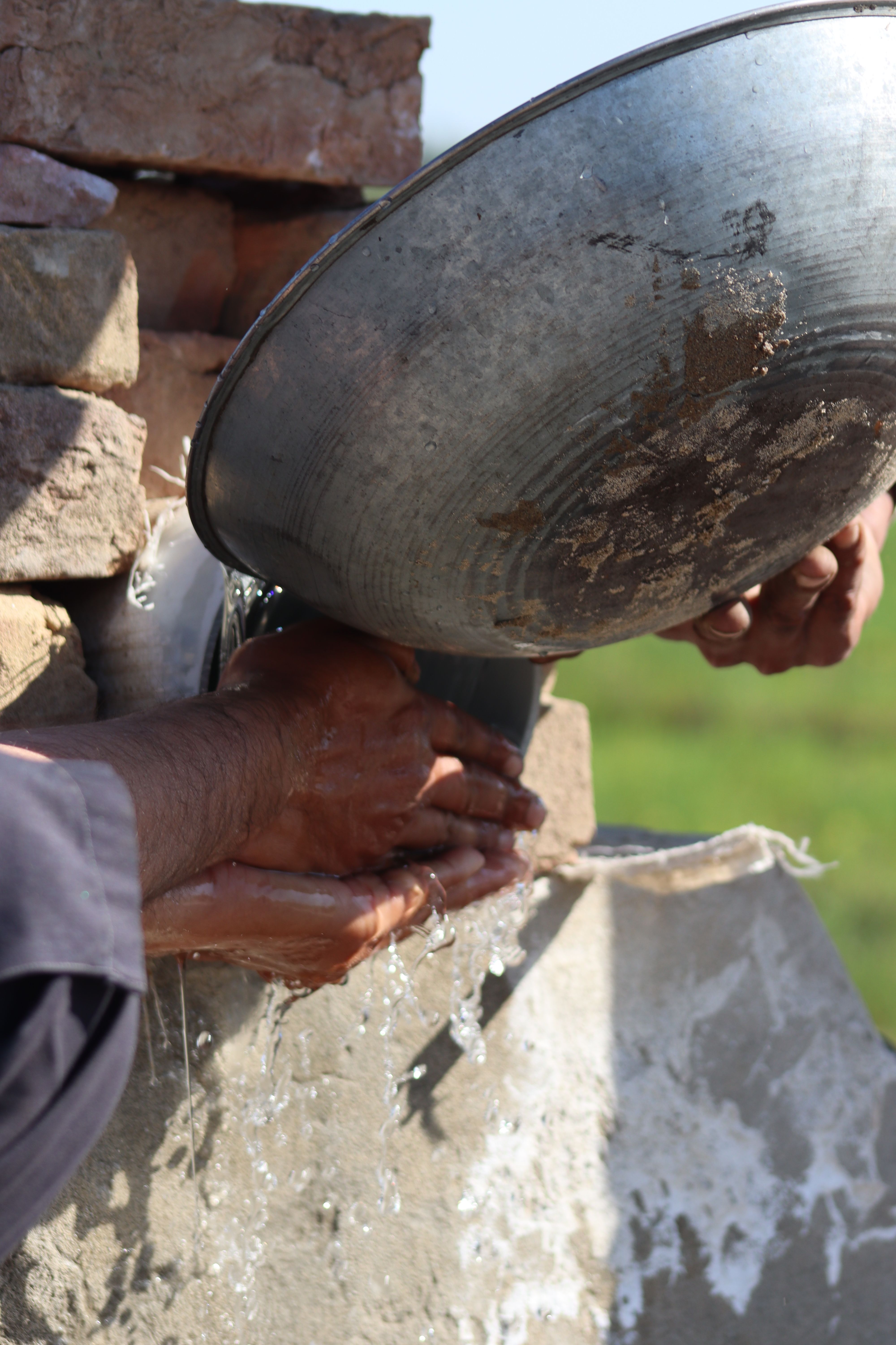 Hands Collecting Water from Outdoor Tap · Free Stock Photo