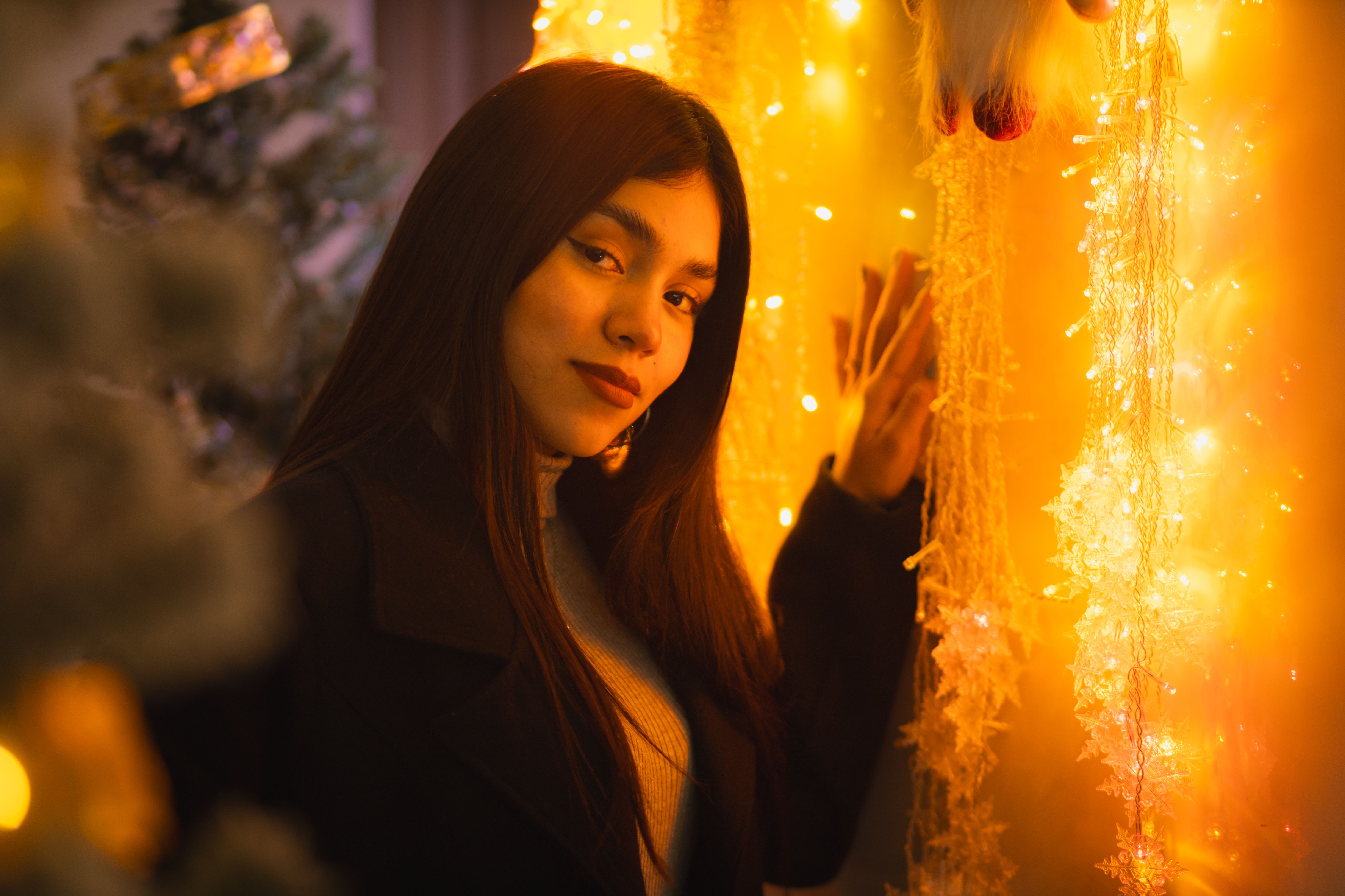 Cozy Winter Portrait with Holiday Lights · Free Stock Photo