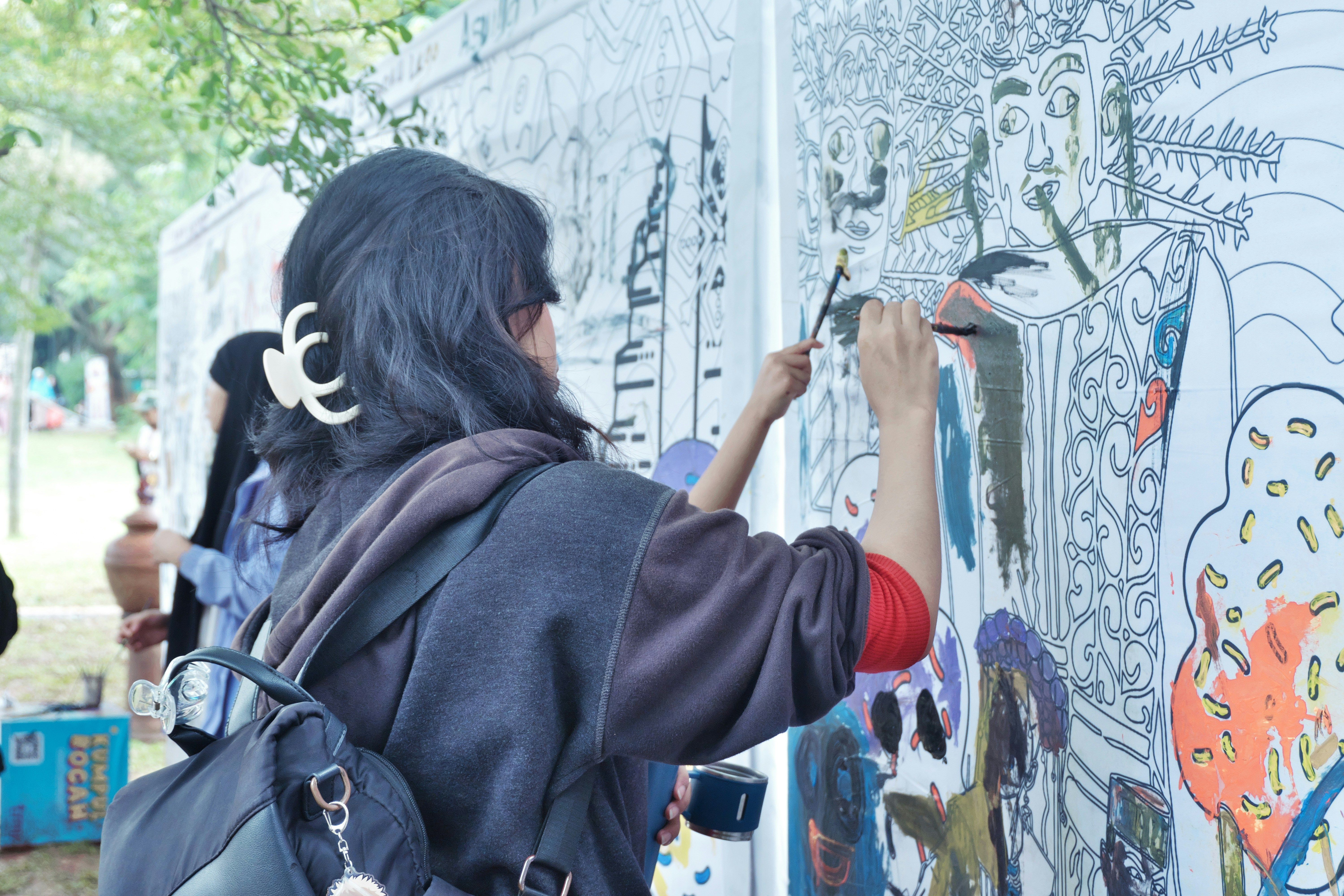 Street Artist Painting Mural in Jakarta Outdoors · Free Stock Photo