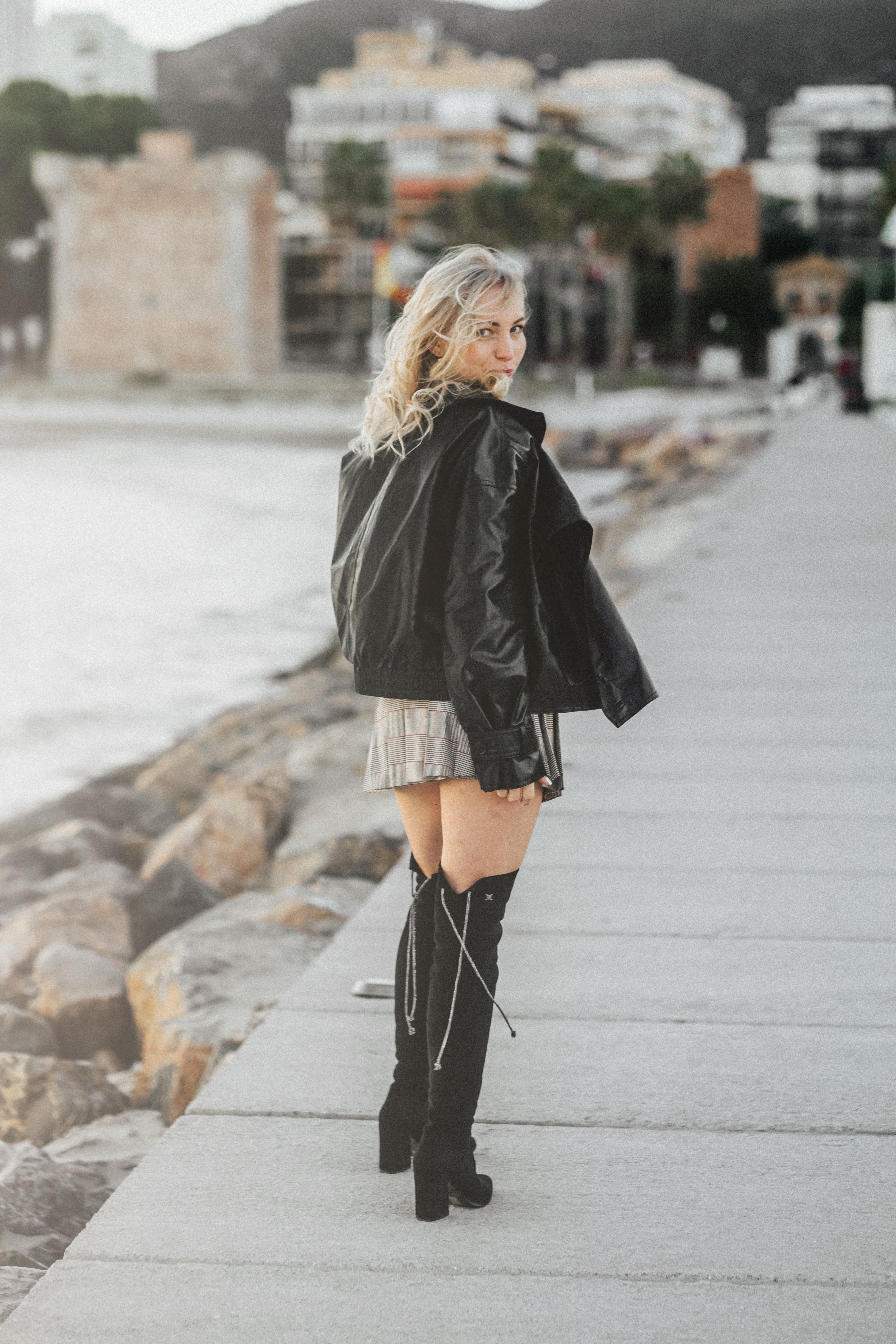 Fashionable Woman in Leather Jacket by Coastal Walkway · Free Stock Photo