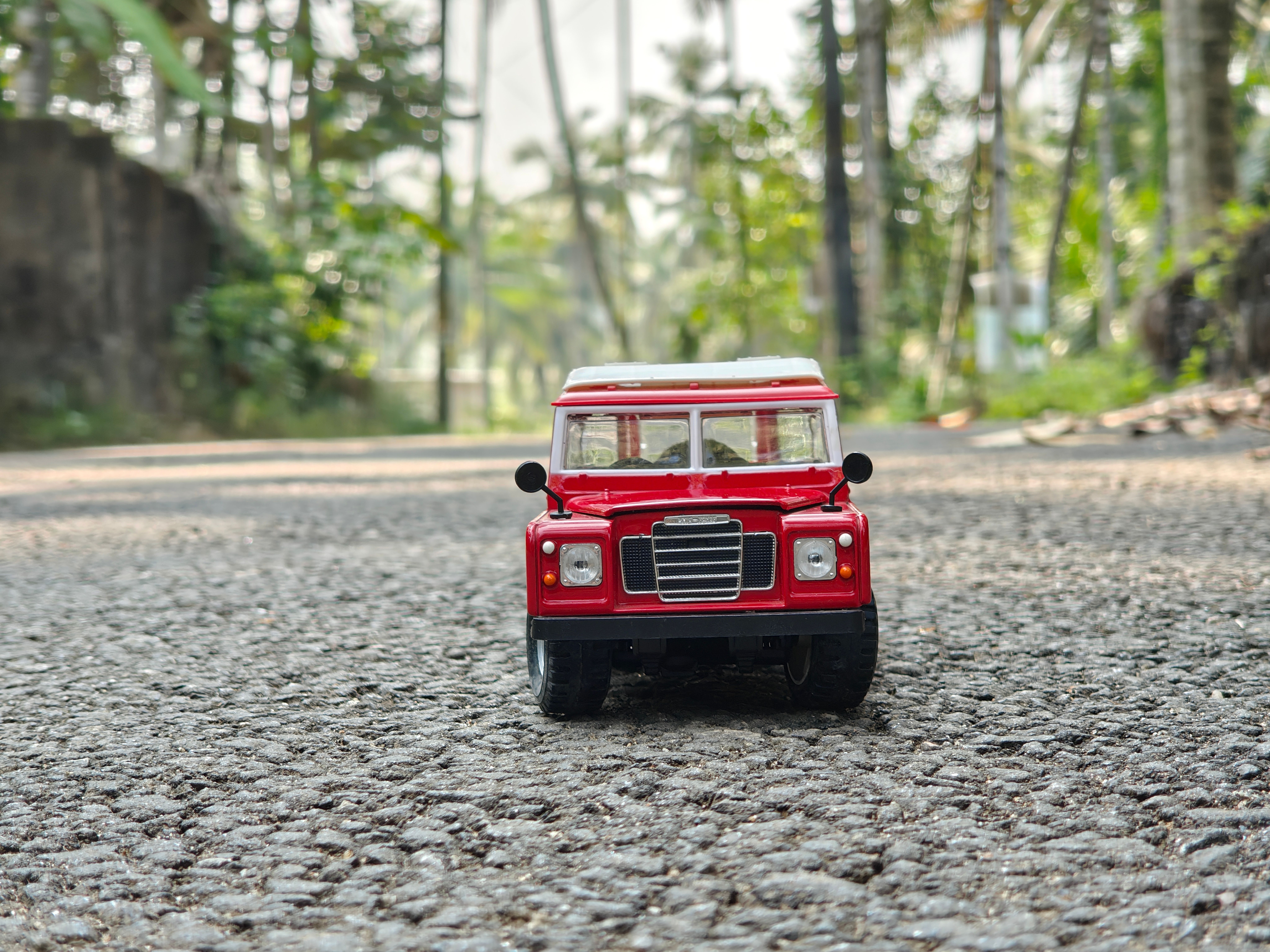 Red Toy Car on a Rugged Outdoor Path · Free Stock Photo