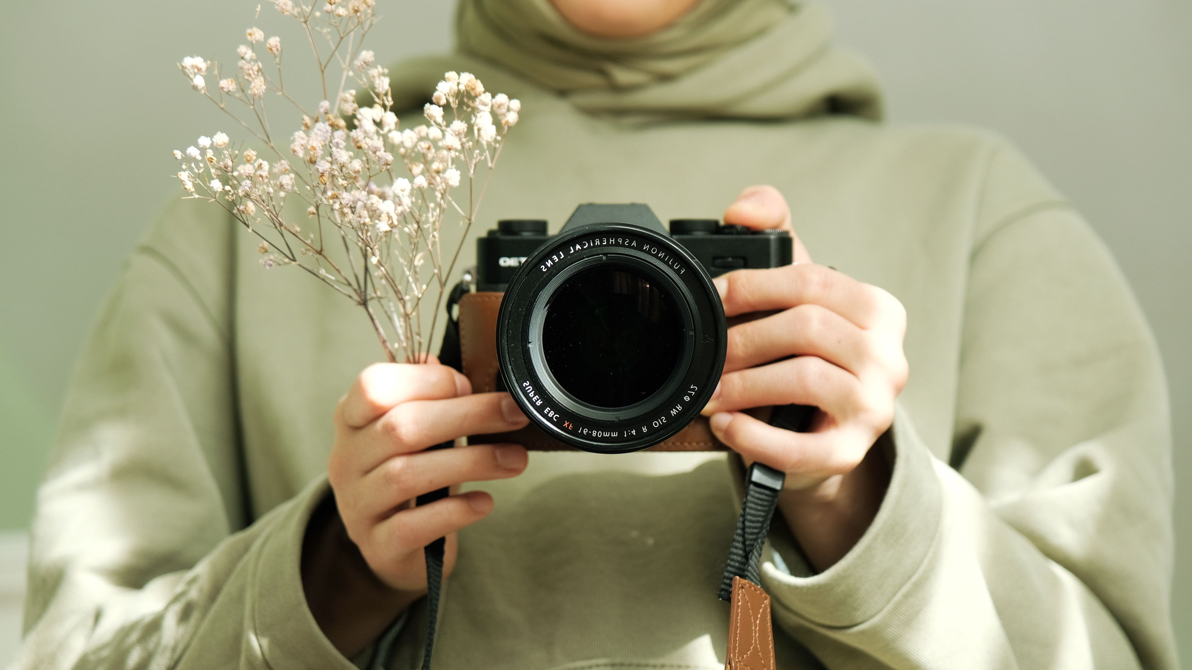 Person Holding Camera with Small Flowers · Free Stock Photo