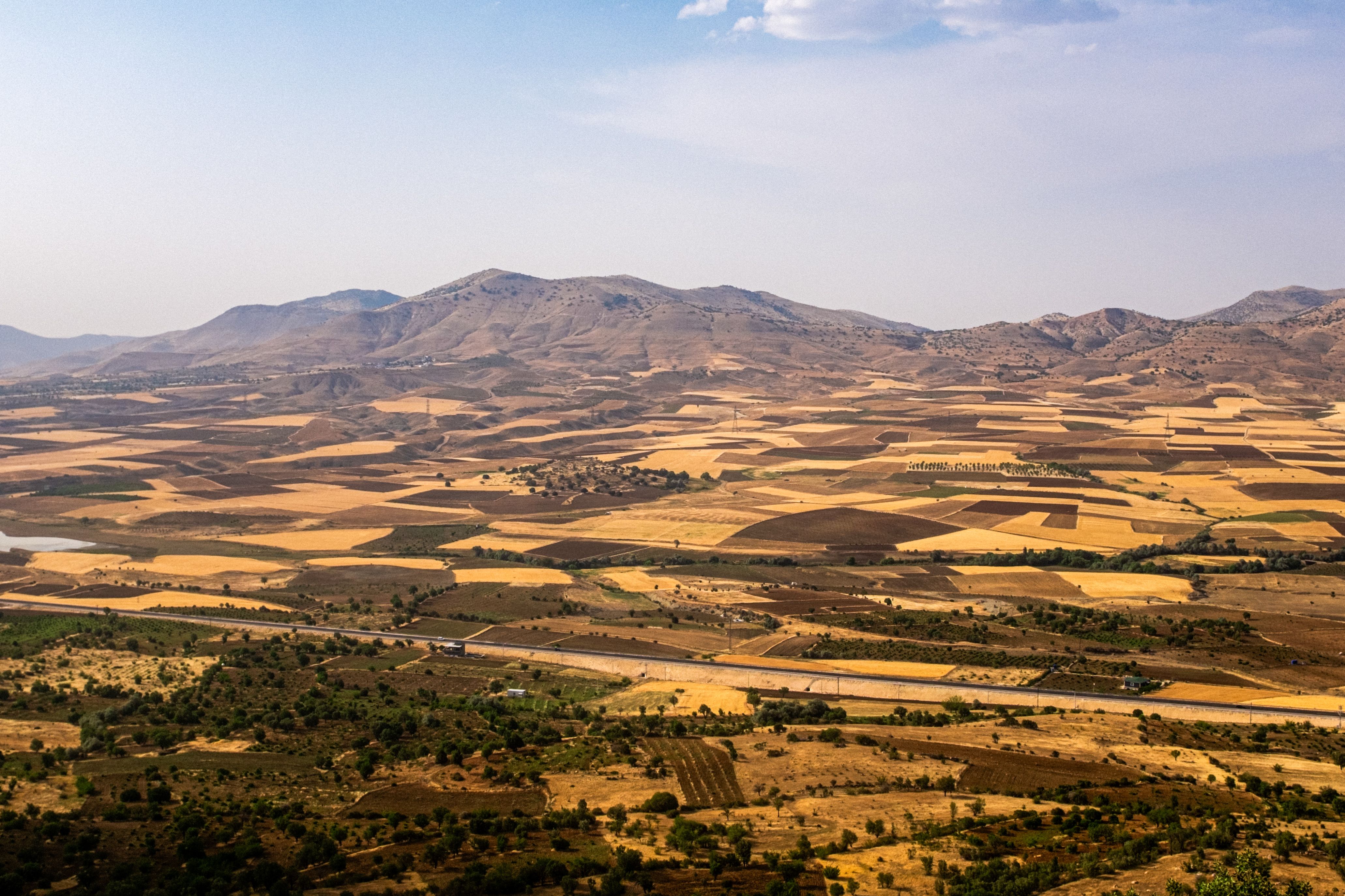 Stunning Aerial View of Patchwork Farmland and Mountains · Free Stock Photo