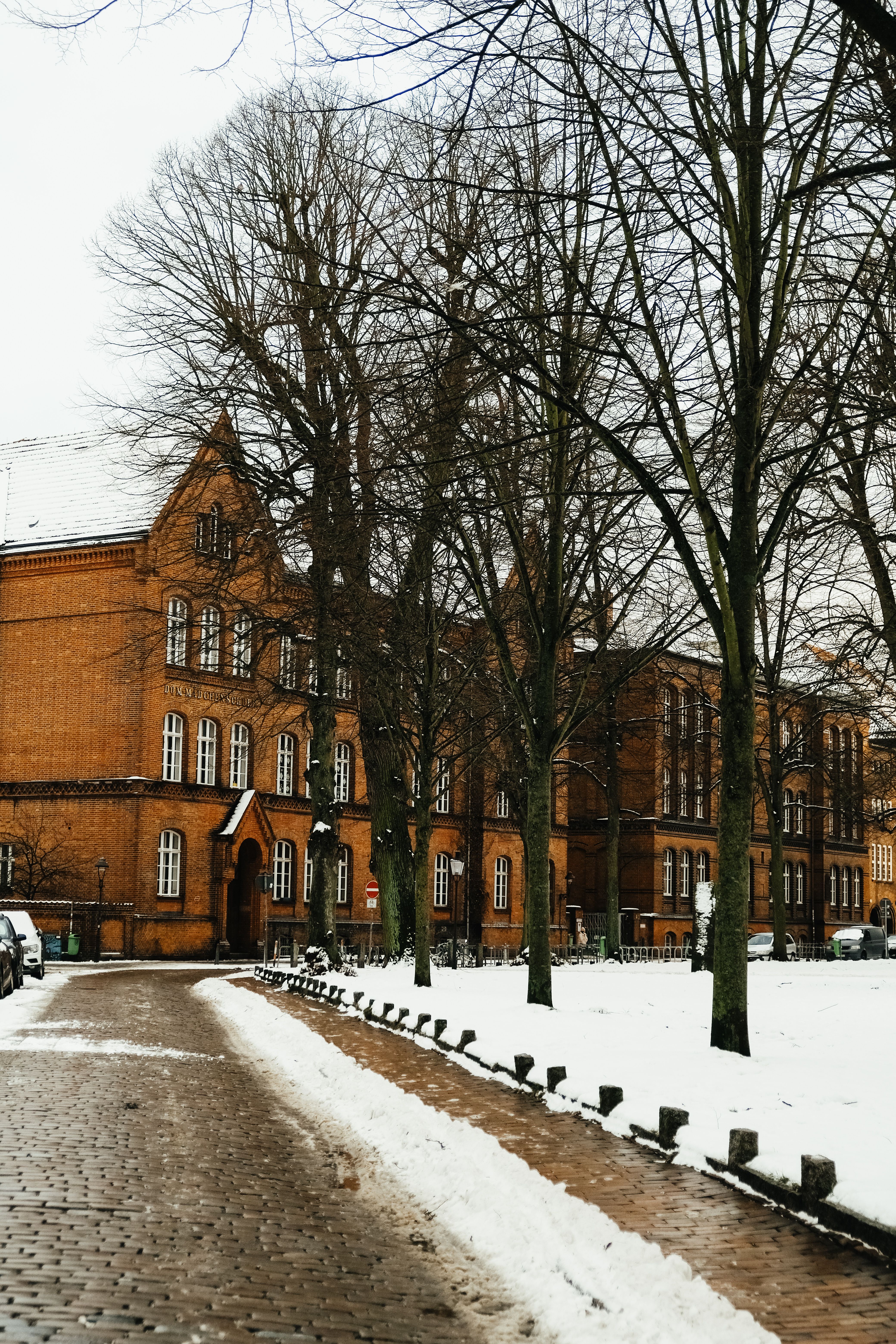 Historic Brick Building in Snowy Winter Setting · Free Stock Photo