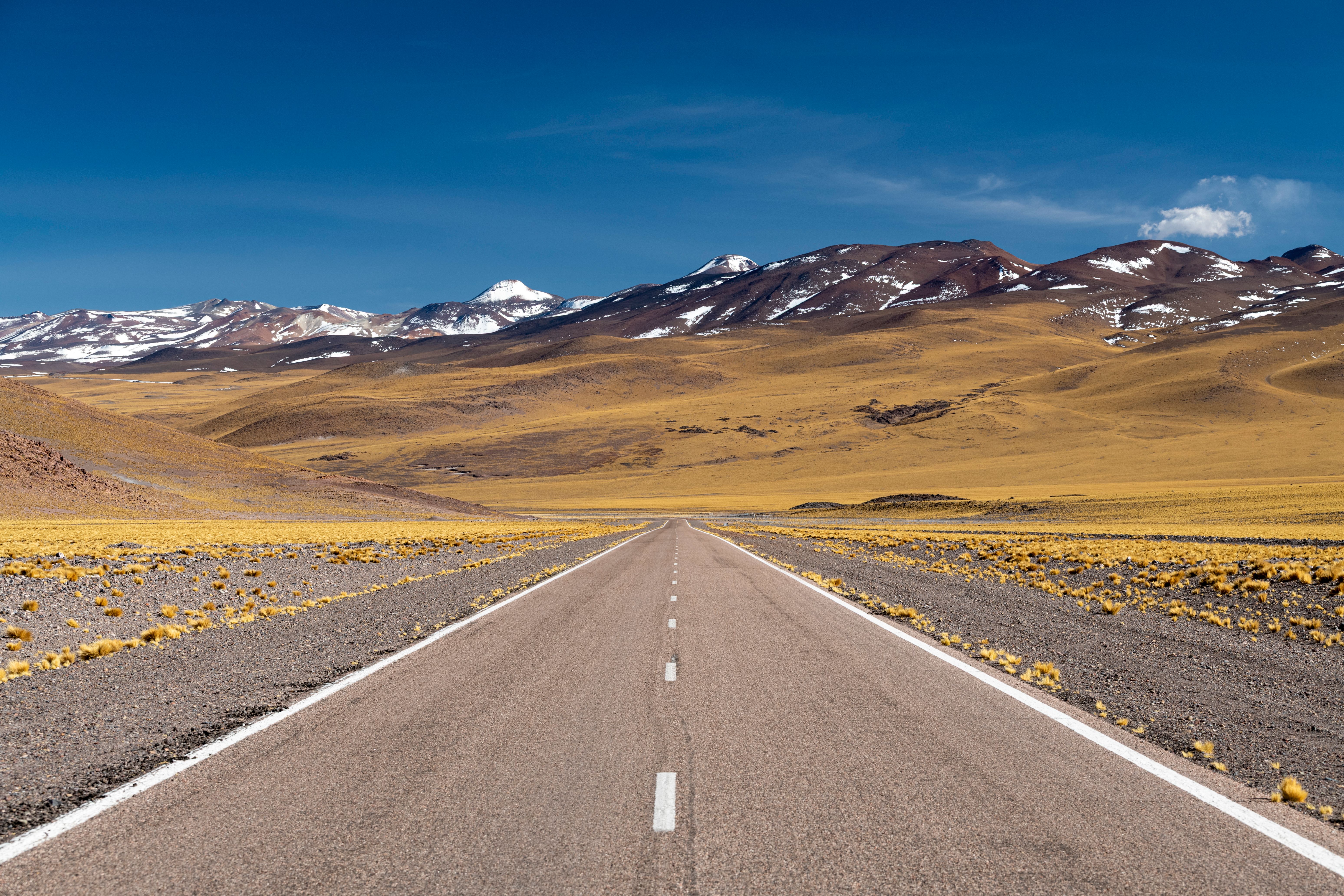 Endless Road through Desert Towards Snow-Capped Mountains · Free Stock ...