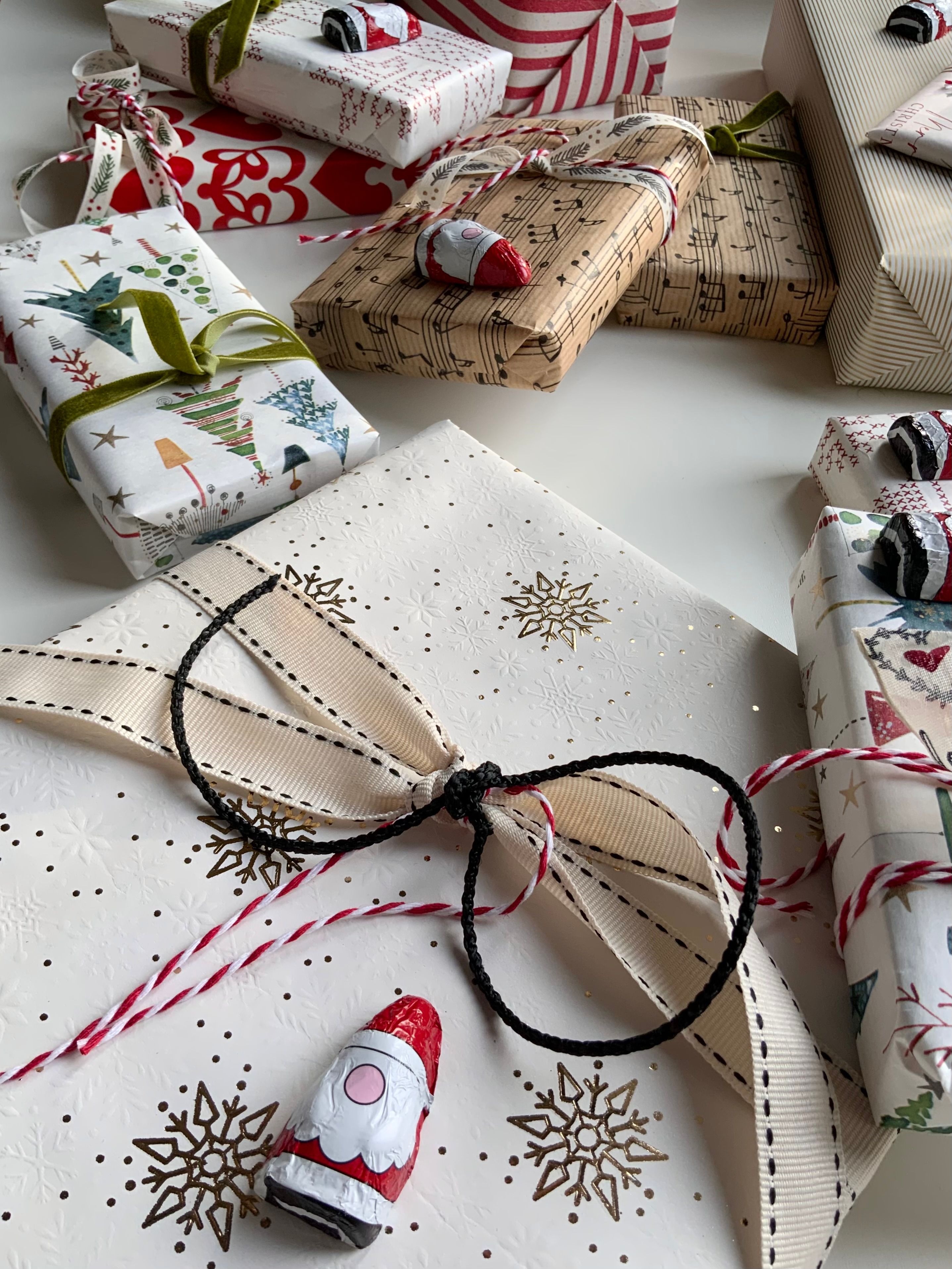 Beautifully Wrapped Christmas Gifts on Table · Free Stock Photo