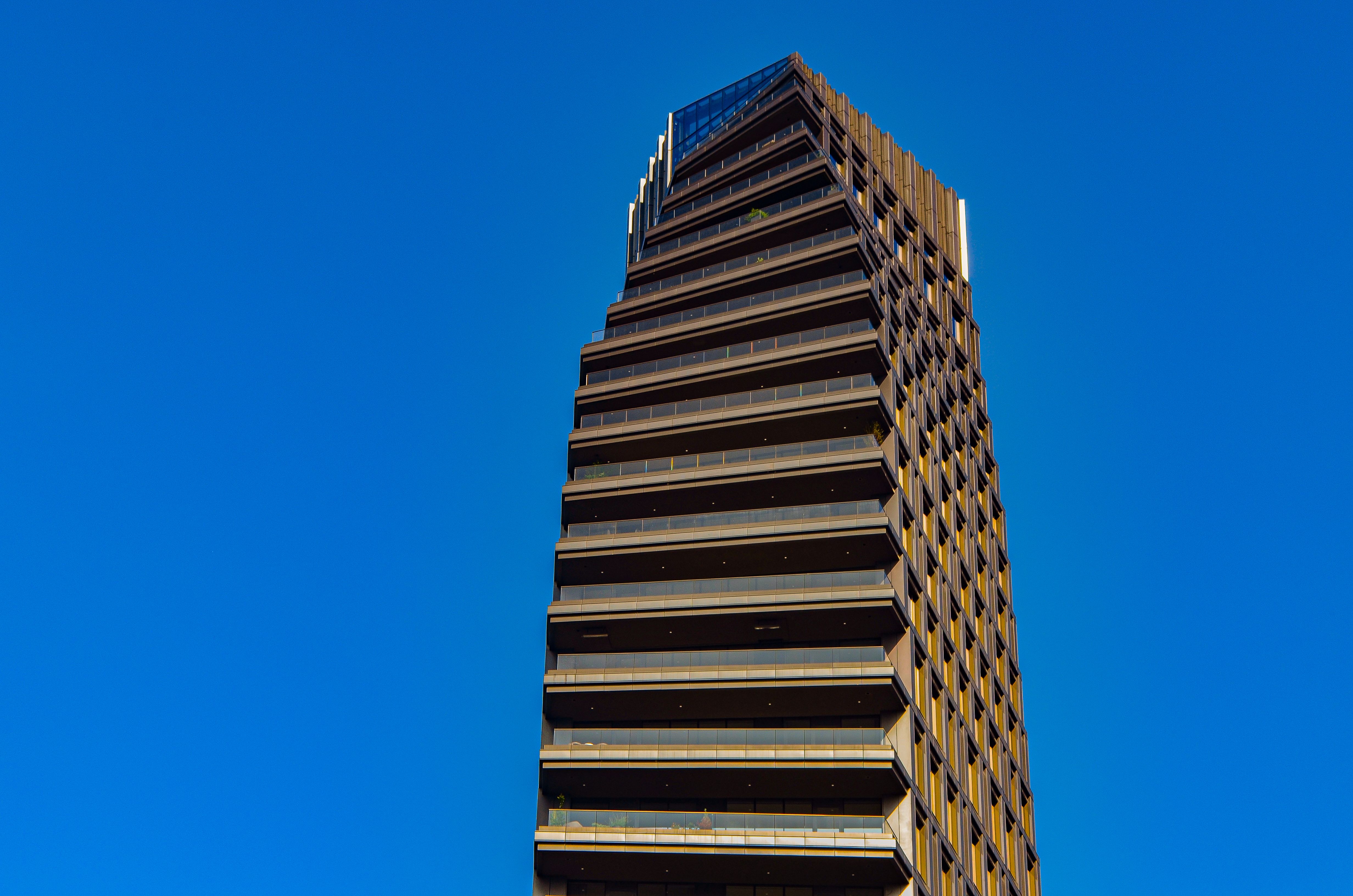 Modern High-Rise Tower Against Clear Blue Sky · Free Stock Photo