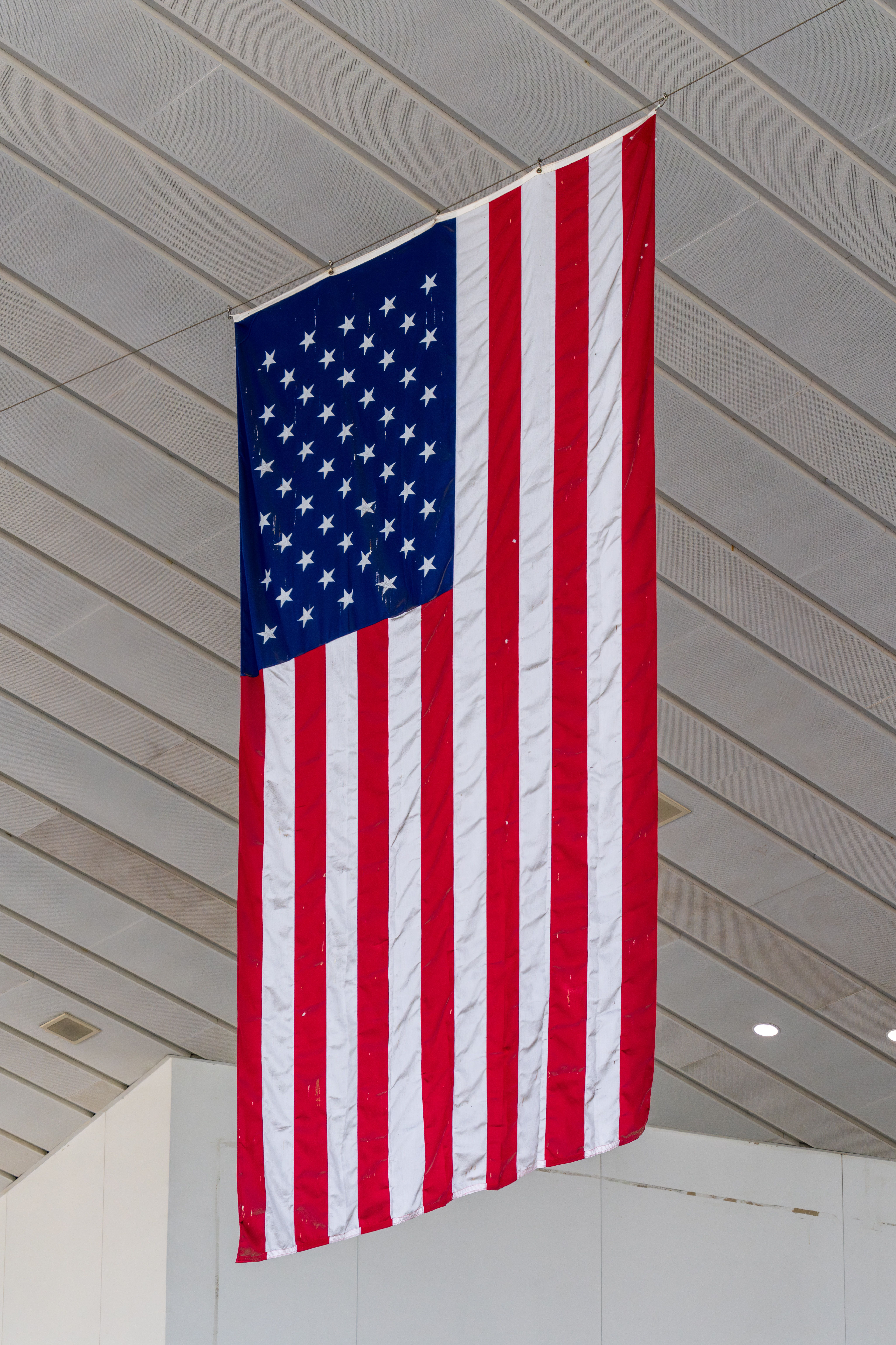USA Flag Hanging Indoors with Modern Ceiling · Free Stock Photo