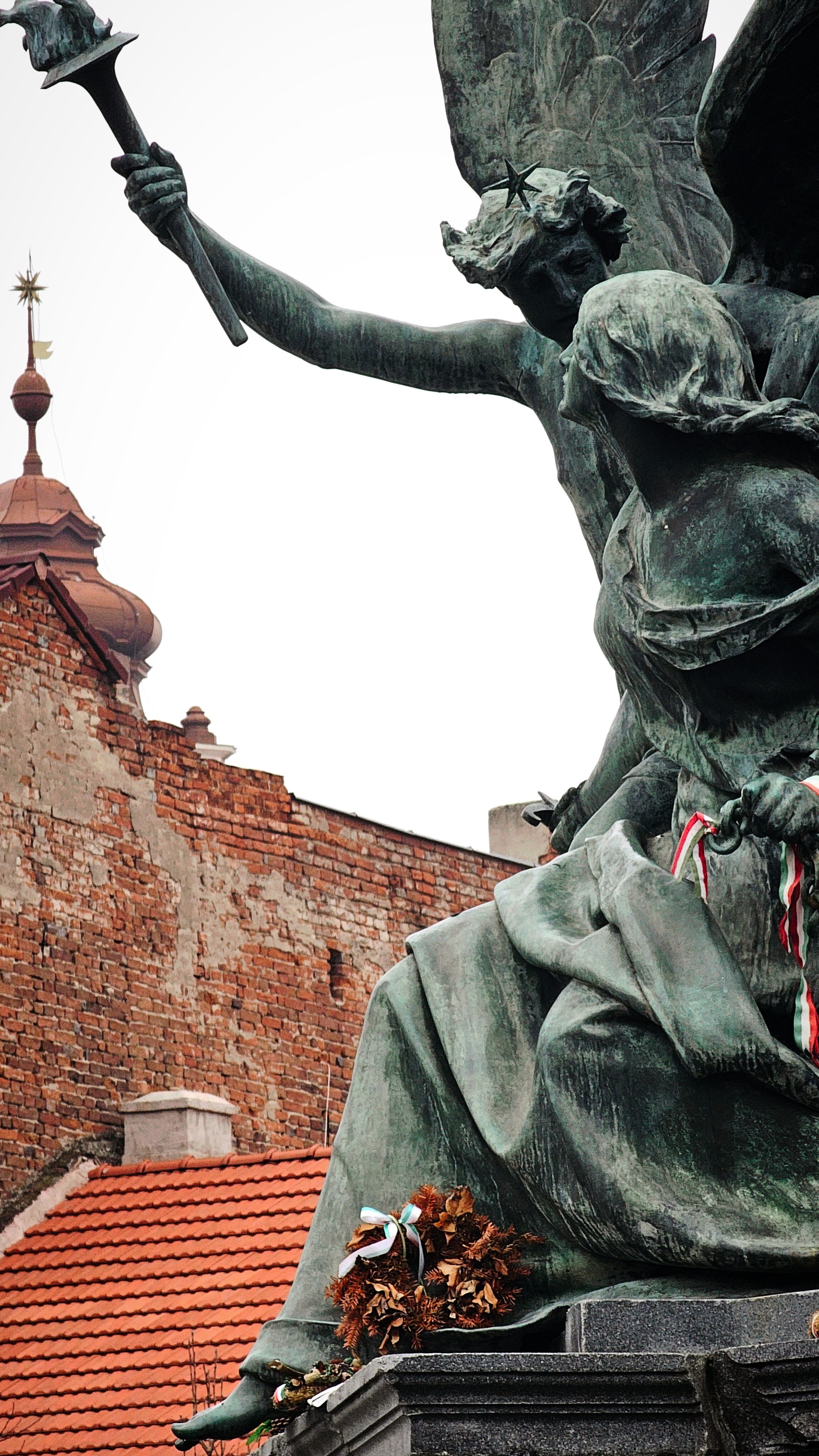 Historic Bronze Statue with Brick Background · Free Stock Photo