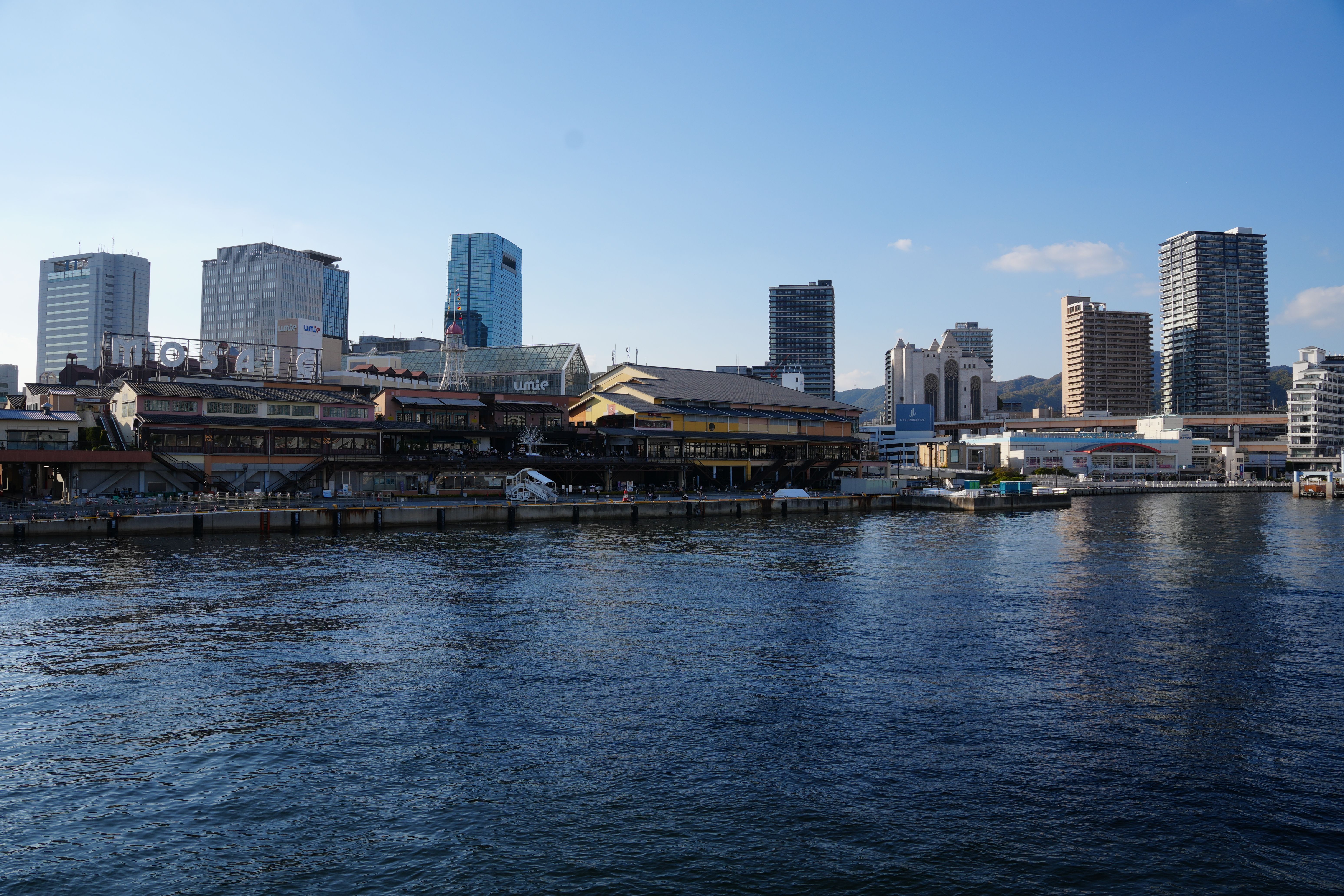 Scenic Waterfront Cityscape with Modern Buildings · Free Stock Photo