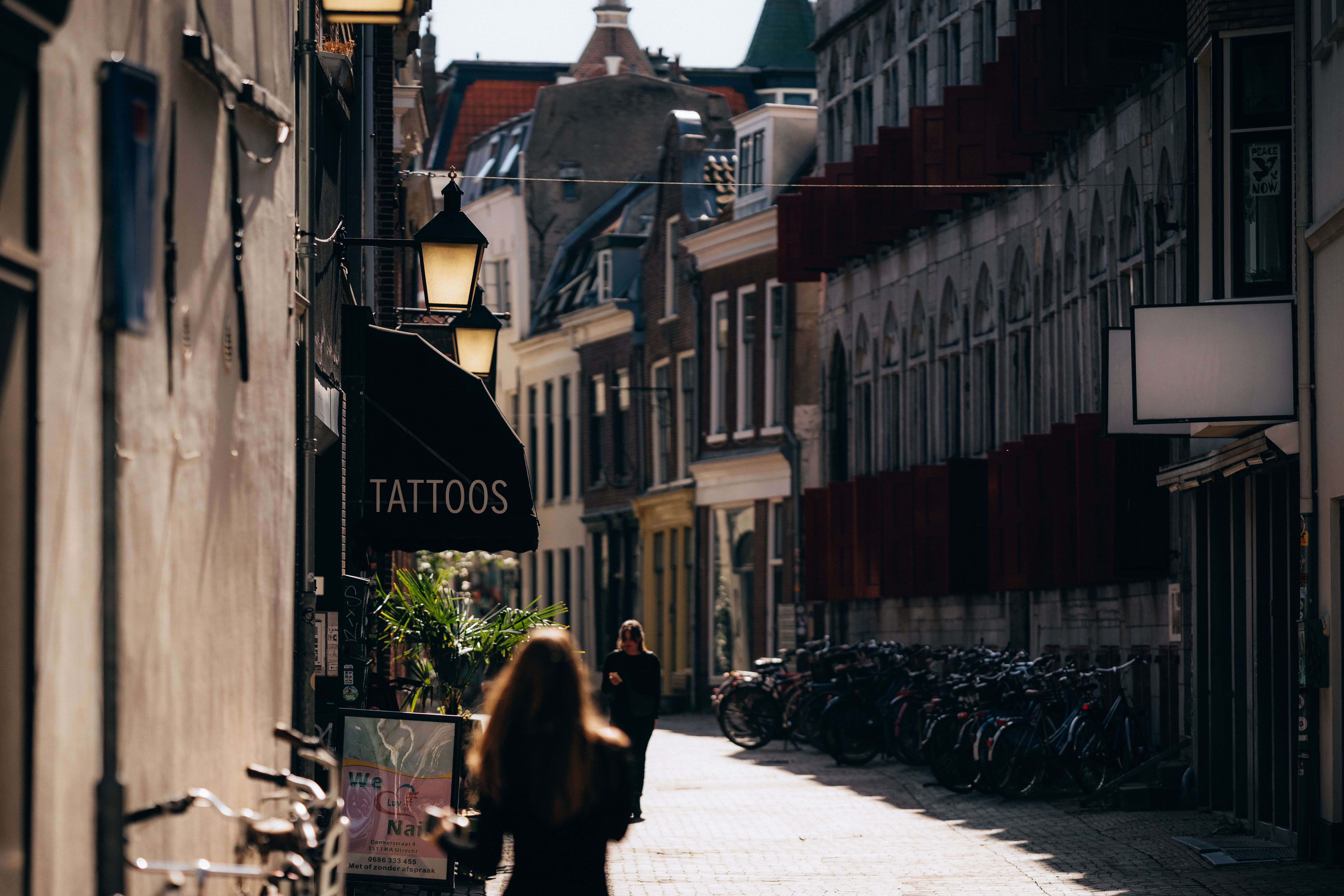 Charming European Alley with Tattoo Parlor · Free Stock Photo