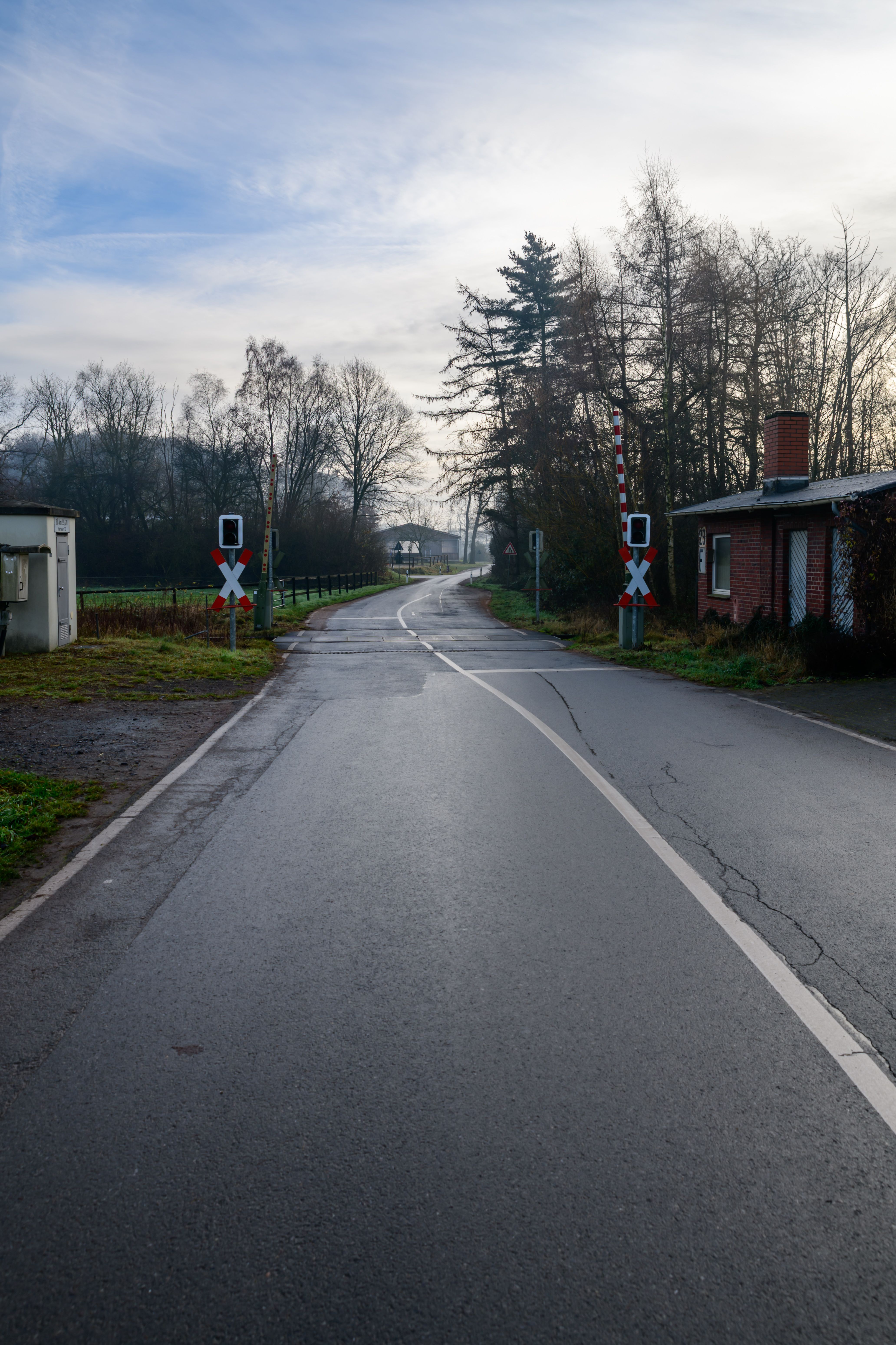 Empty Rural Railway Crossing in Overcast Weather · Free Stock Photo