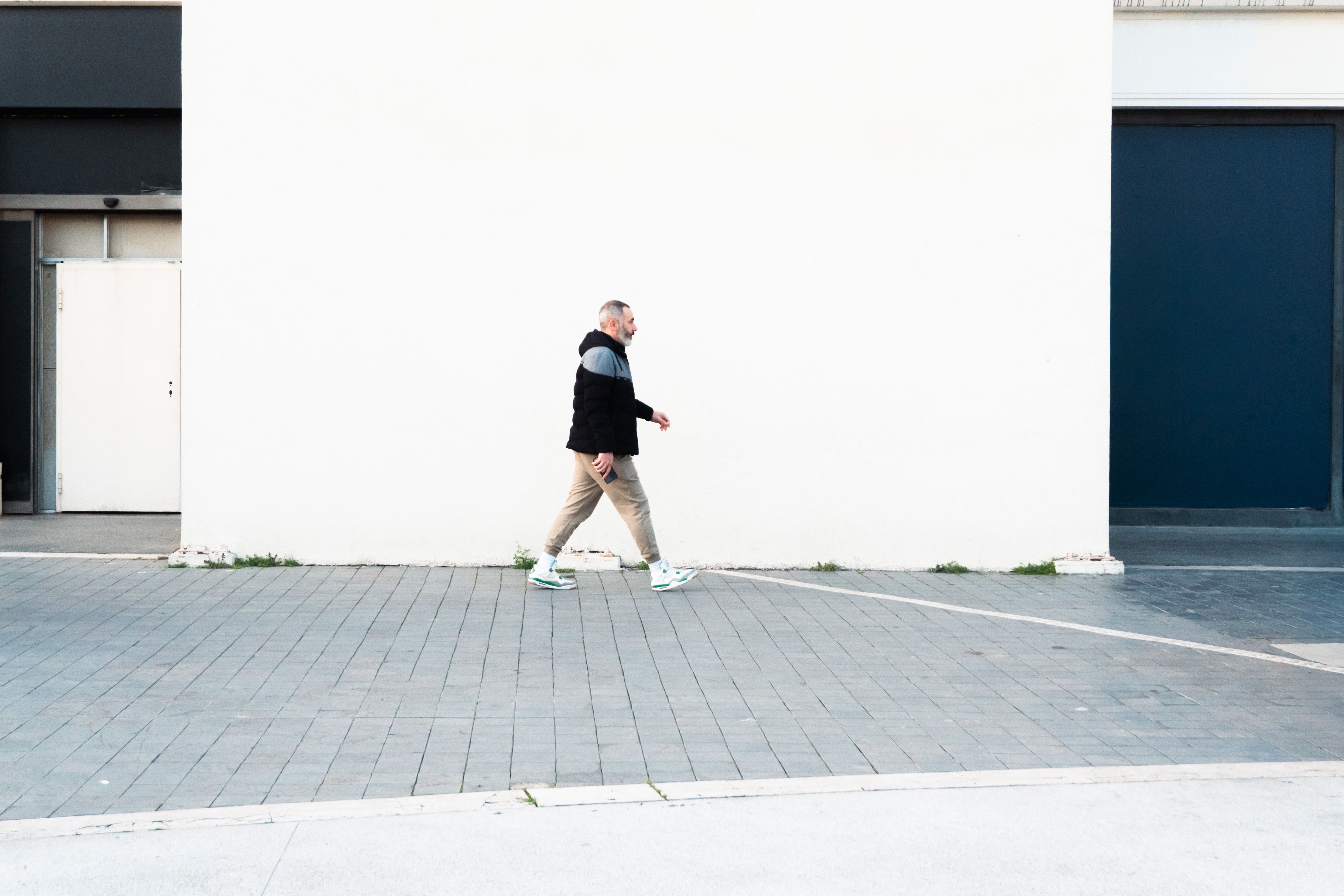 Man Walking by Minimalist Urban Wall in Istanbul · Free Stock Photo