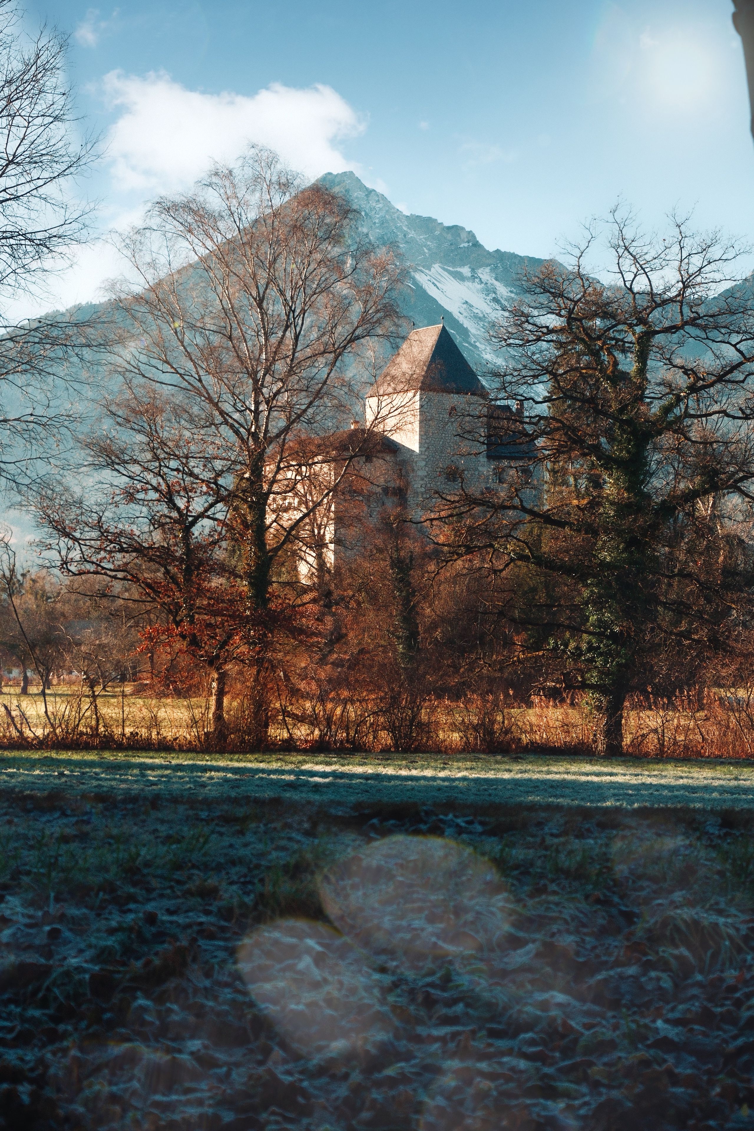 Rustic Castle with Snow-Capped Mountain Backdrop · Free Stock Photo