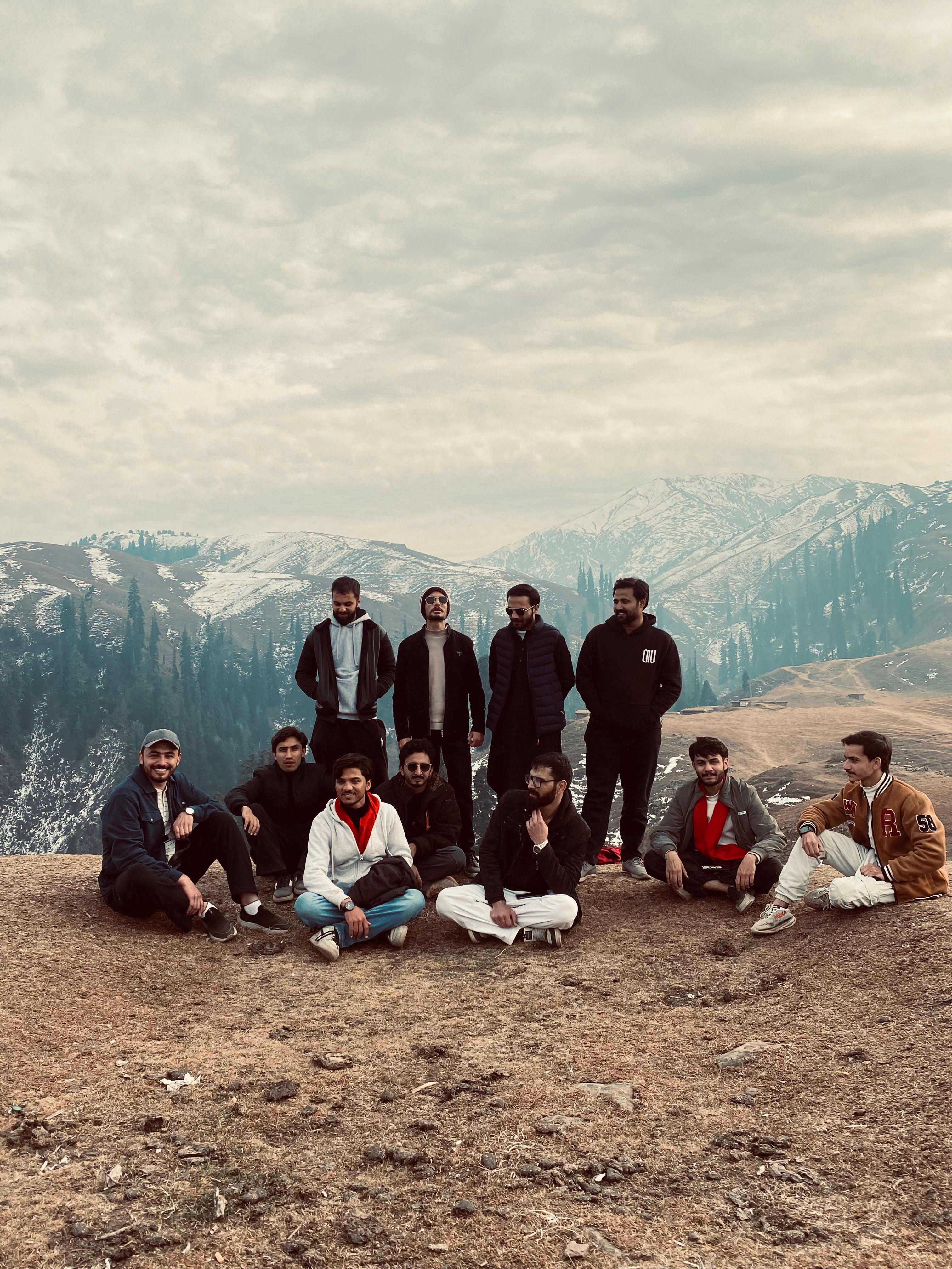 Group of Friends Relaxing in Mountain Landscape · Free Stock Photo