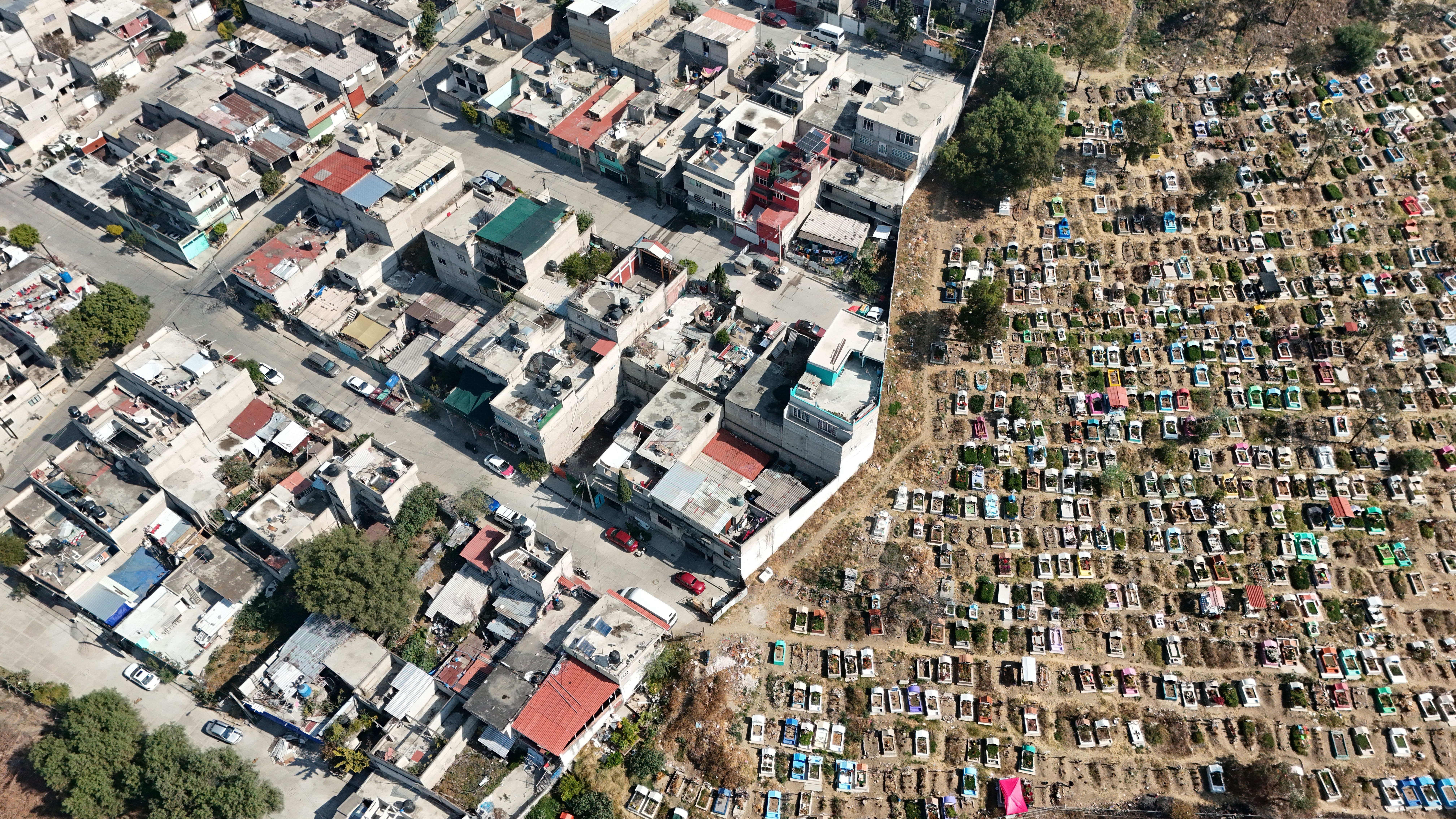 Aerial View of Urban Area and Adjacent Cemetery · Free Stock Photo