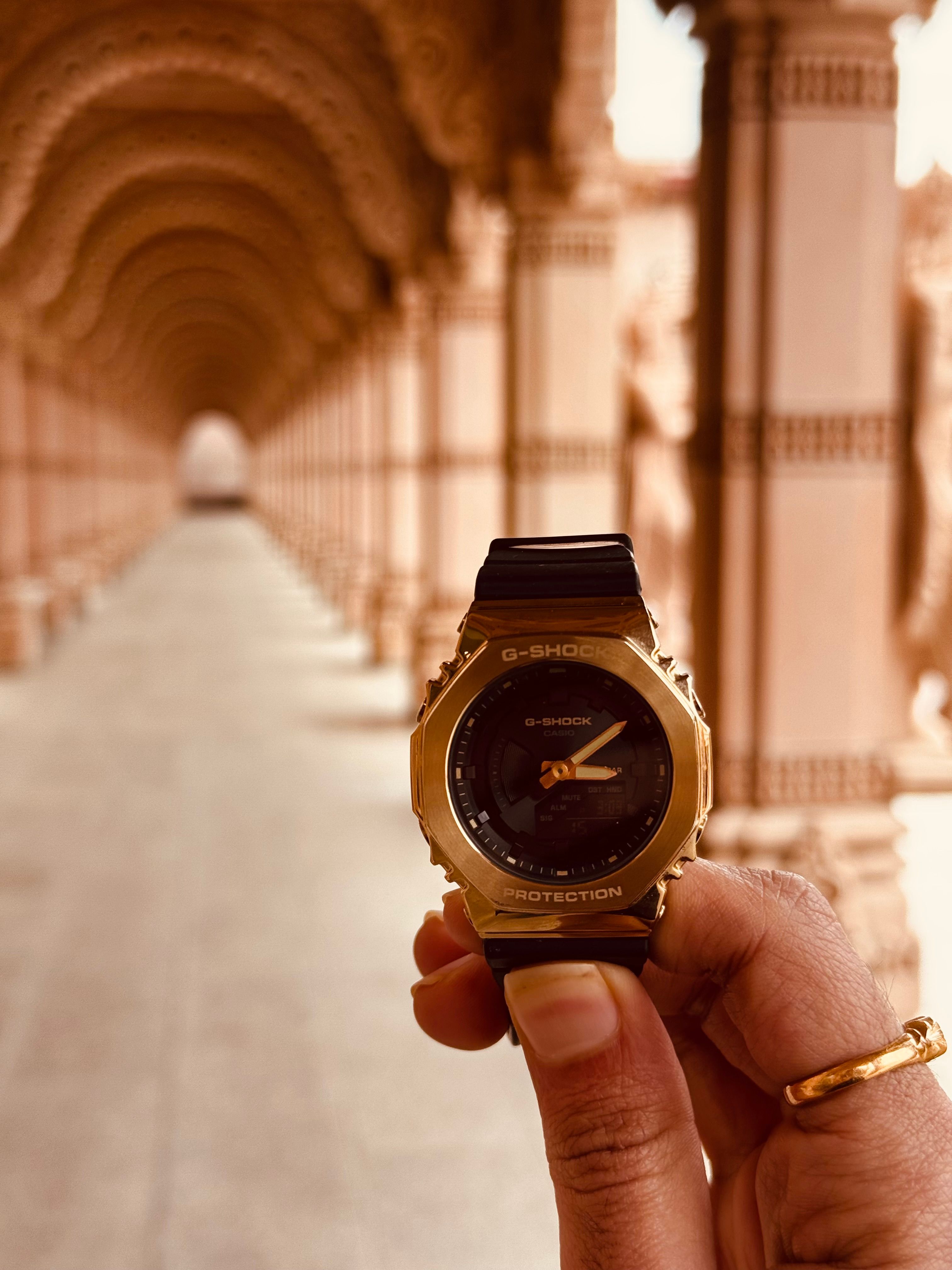 Close-up of Hand Holding Watch with Architectural Background · Free ...