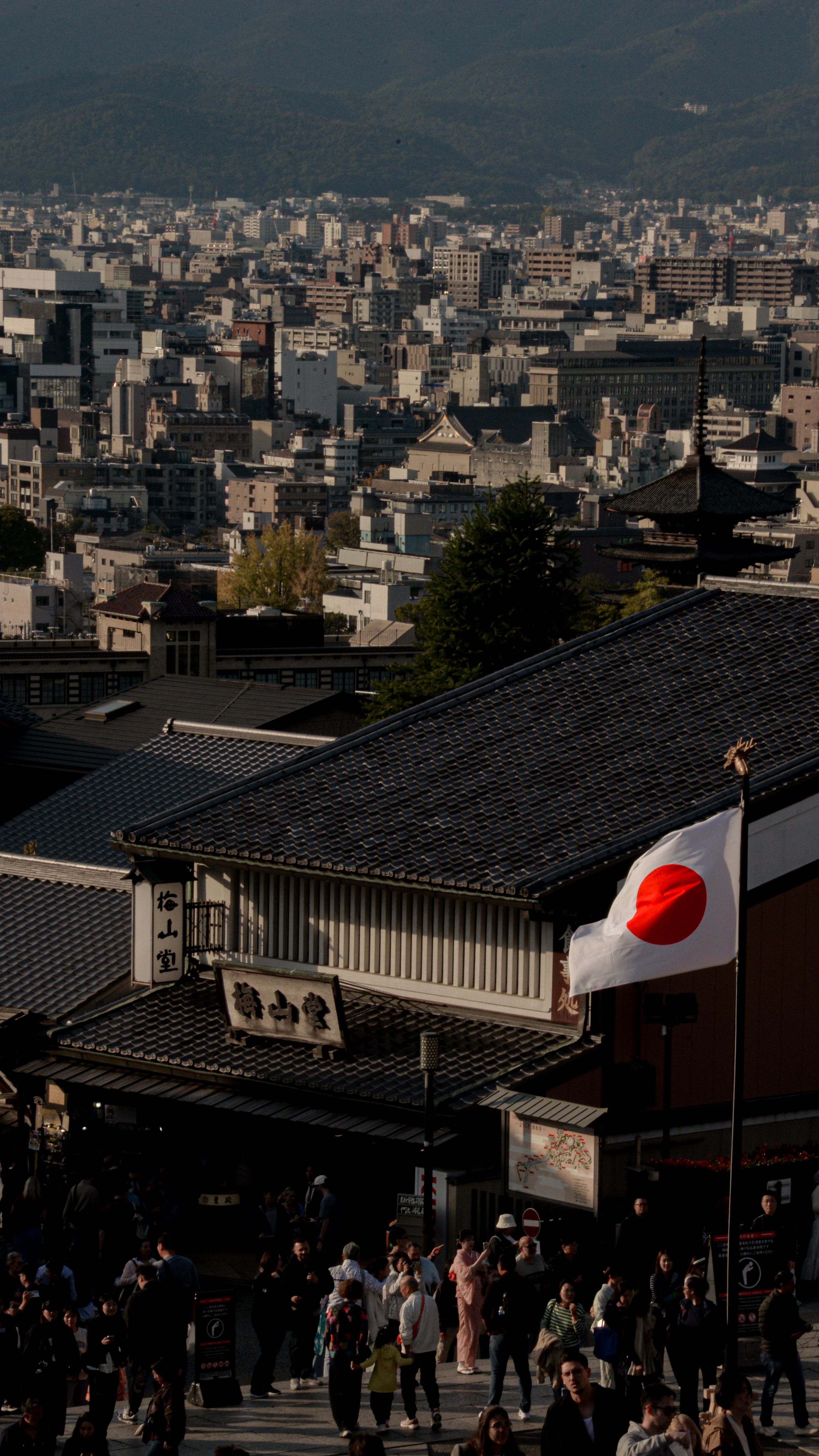 Vibrant Cityscape of Kyoto with Japanese Flag · Free Stock Photo