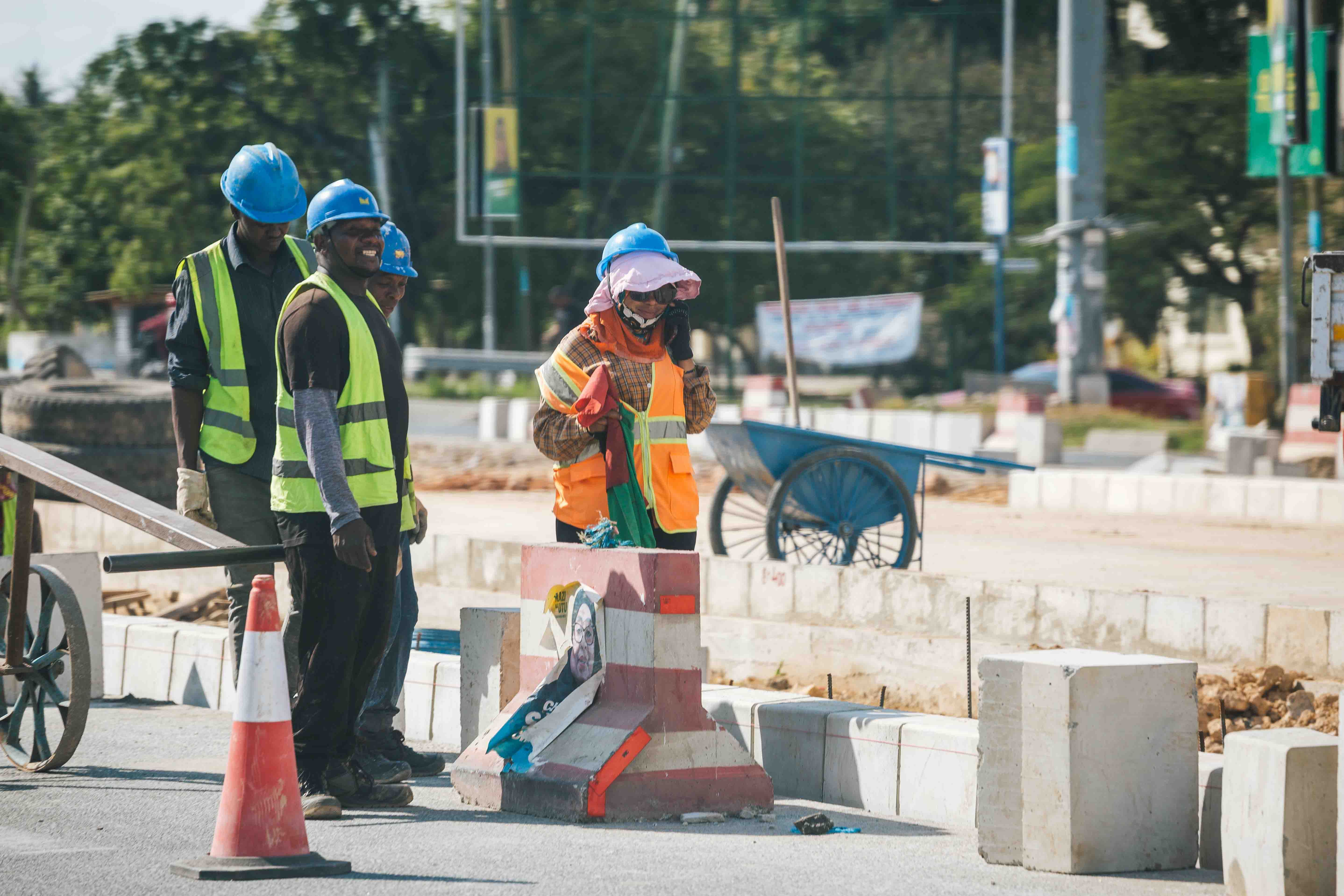 Group of Construction Workers in Blue Uniforms · Free Stock Photo