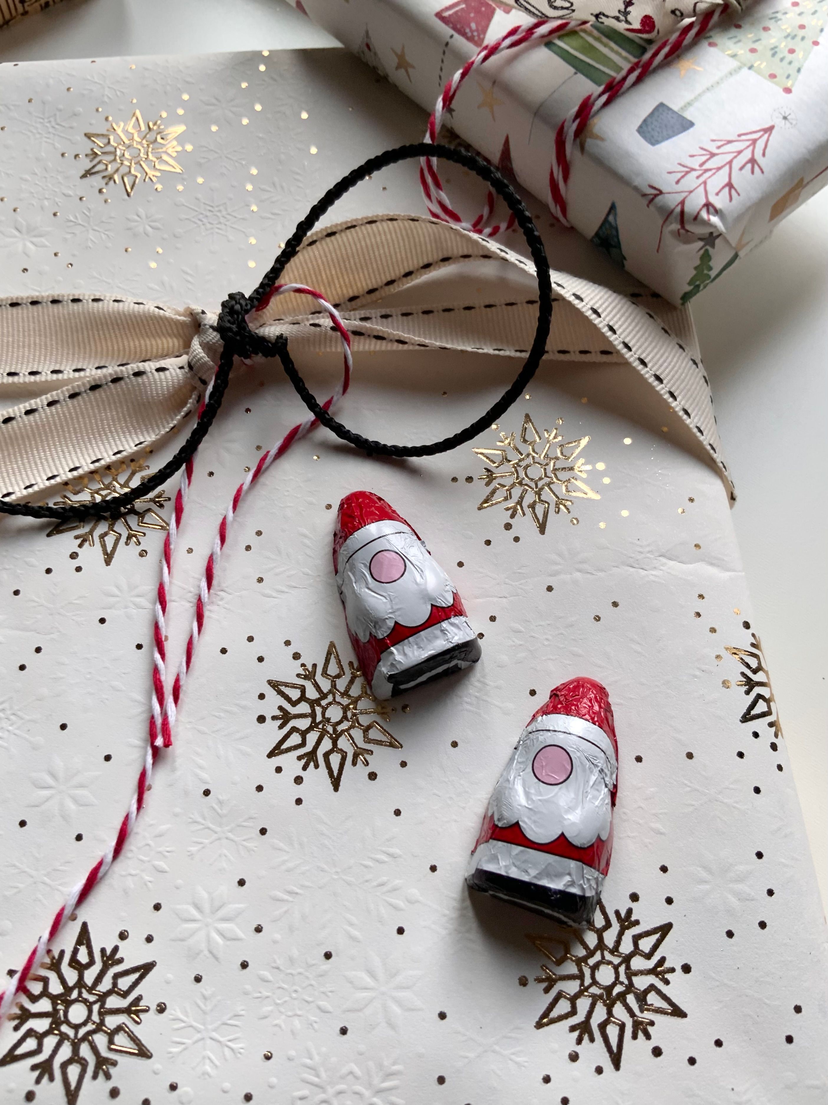 Festive Gnome Gift Wrapping with Snowflake Design · Free Stock Photo
