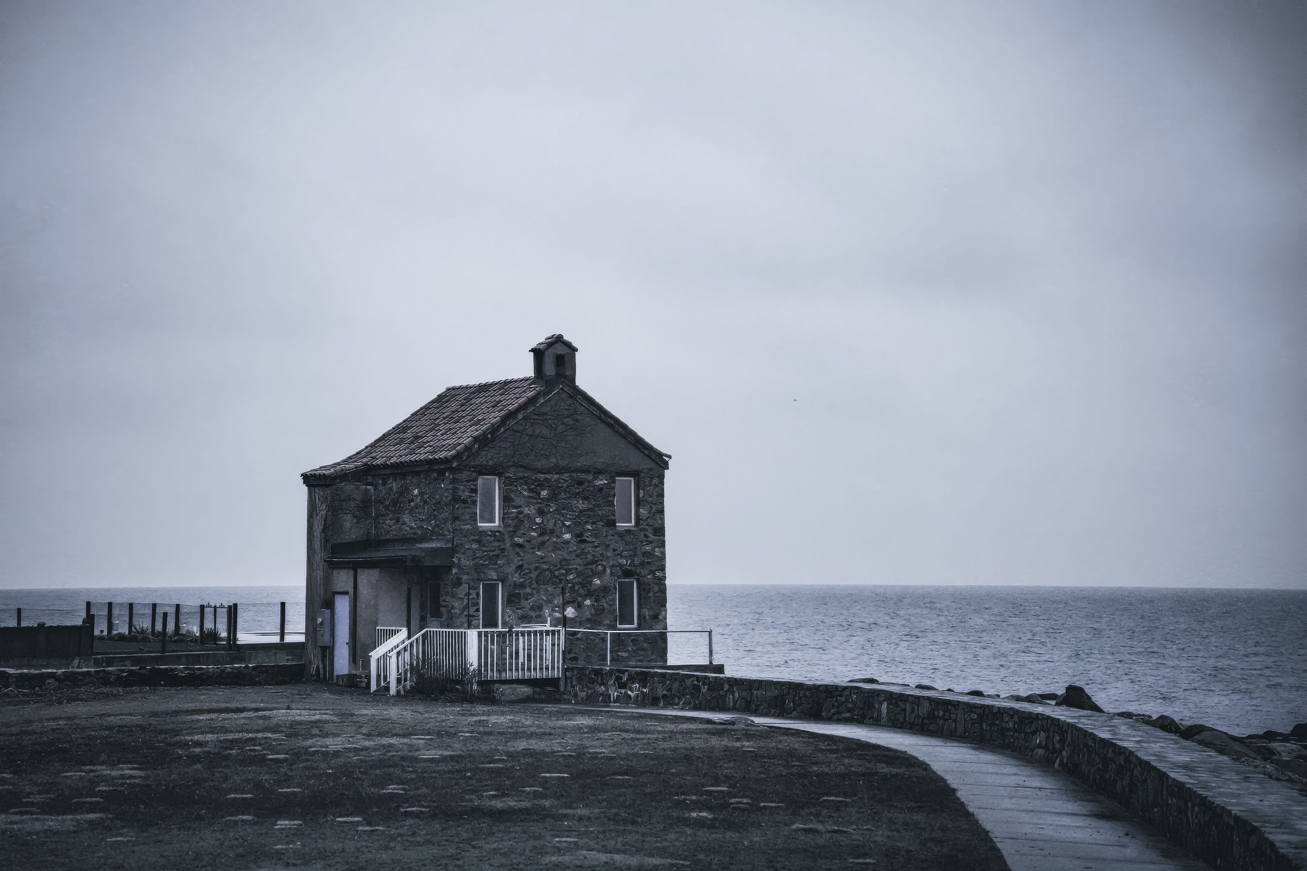 Solitary Stone House by the Sea on Overcast Day · Free Stock Photo