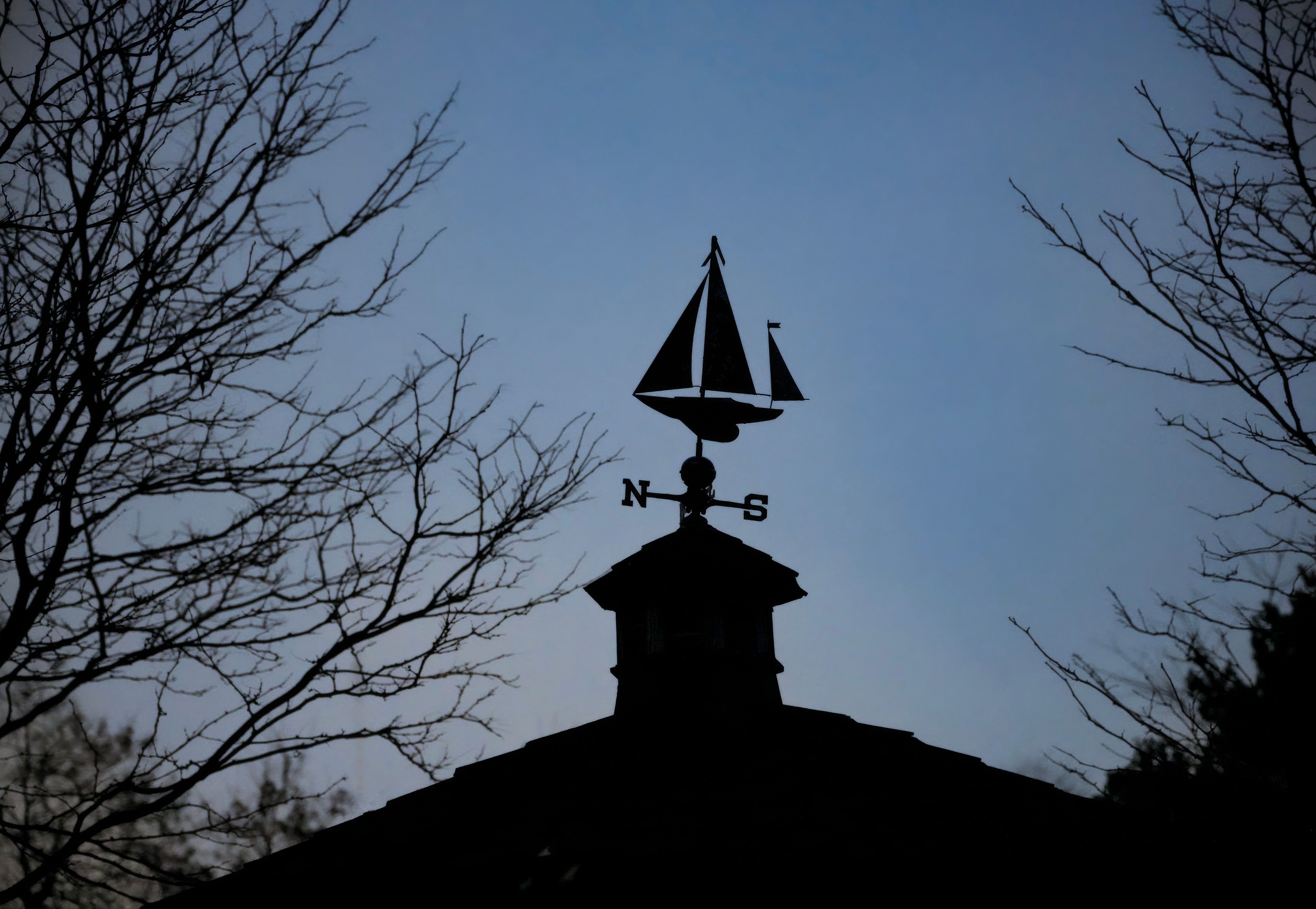 Silhouette of Sailboat Weathervane at Dusk · Free Stock Photo