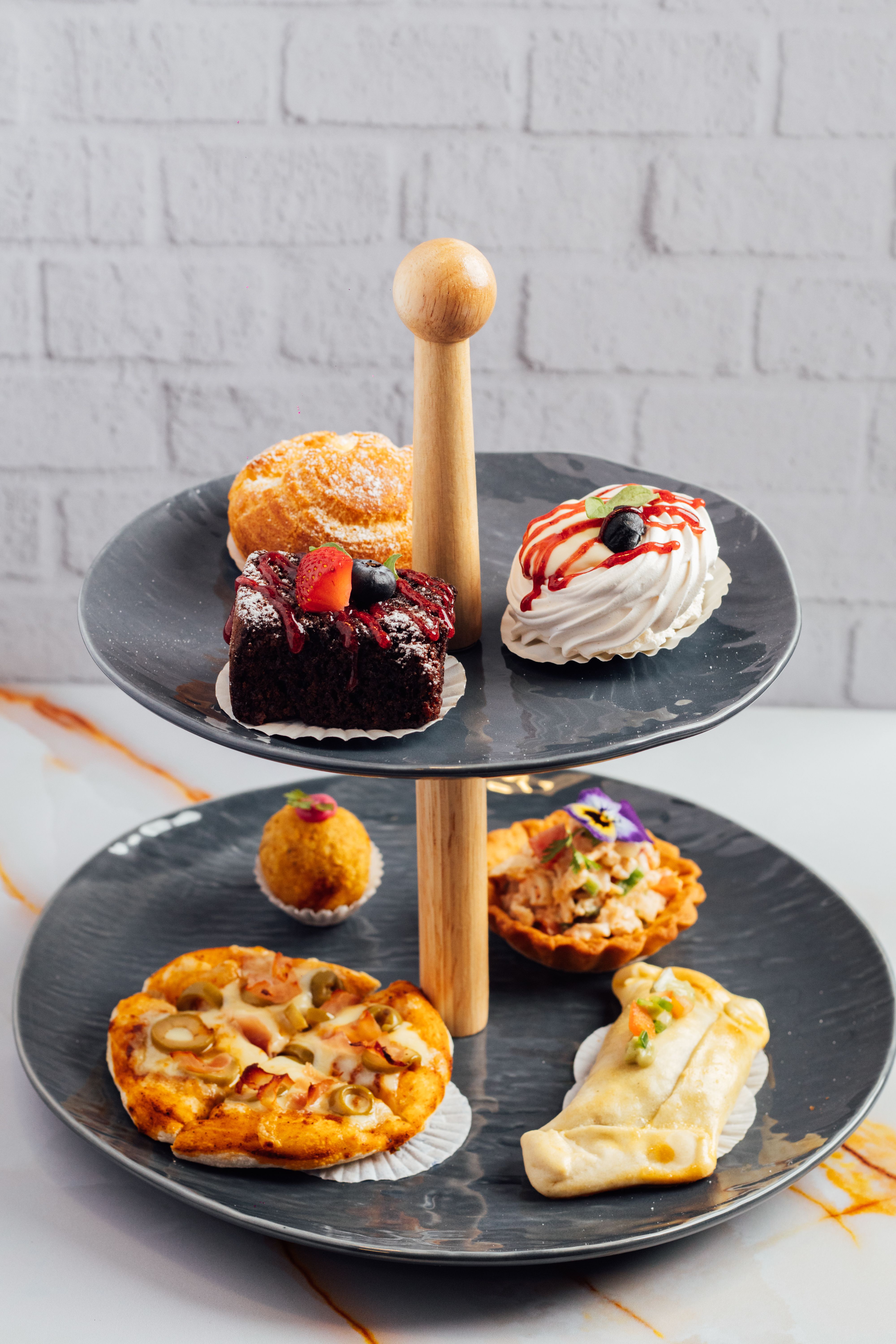 Elegant Dessert and Savory Pastries on Stand · Free Stock Photo